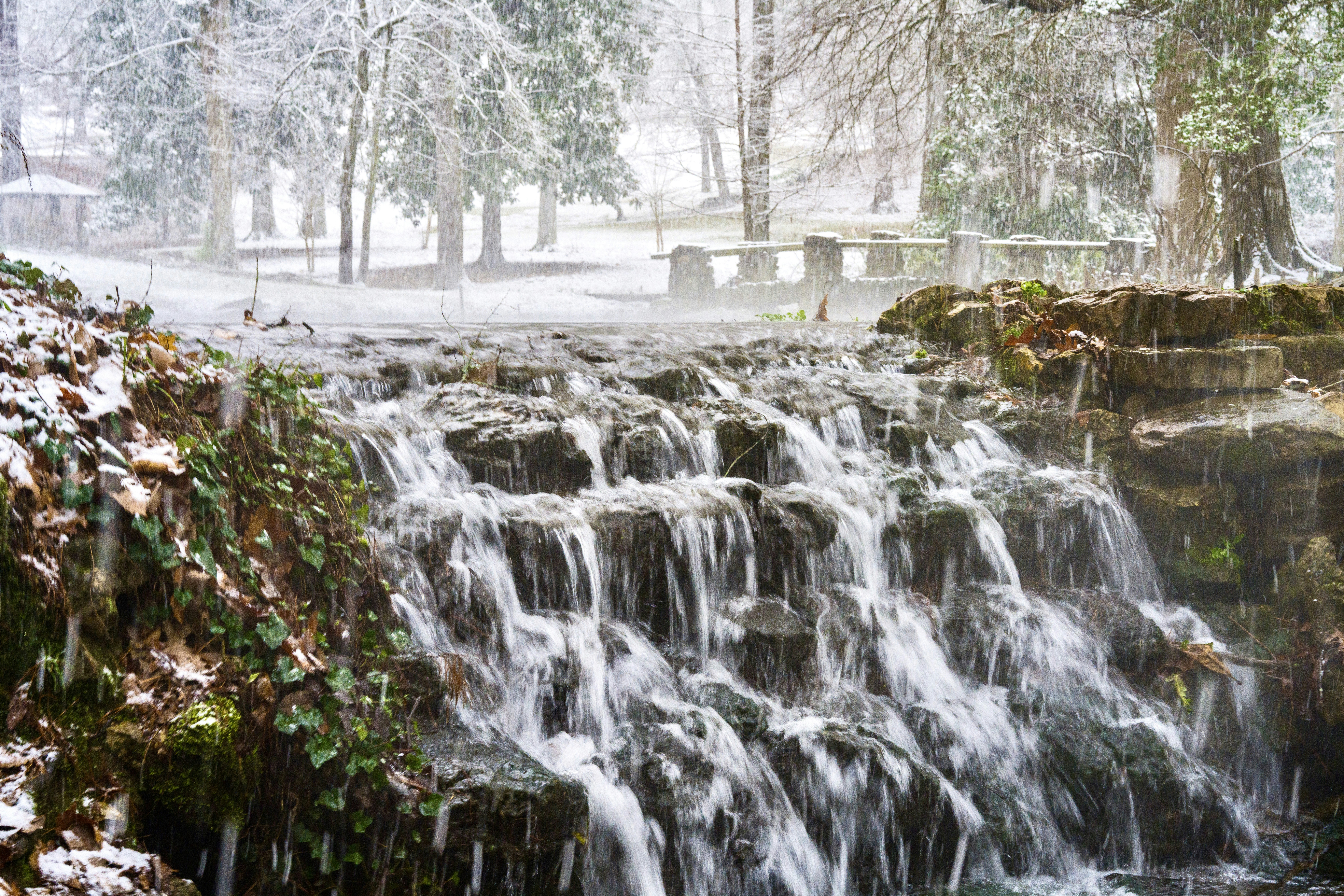Winterveil Cascade: Mossy Stones and Snow in a Quiet Park