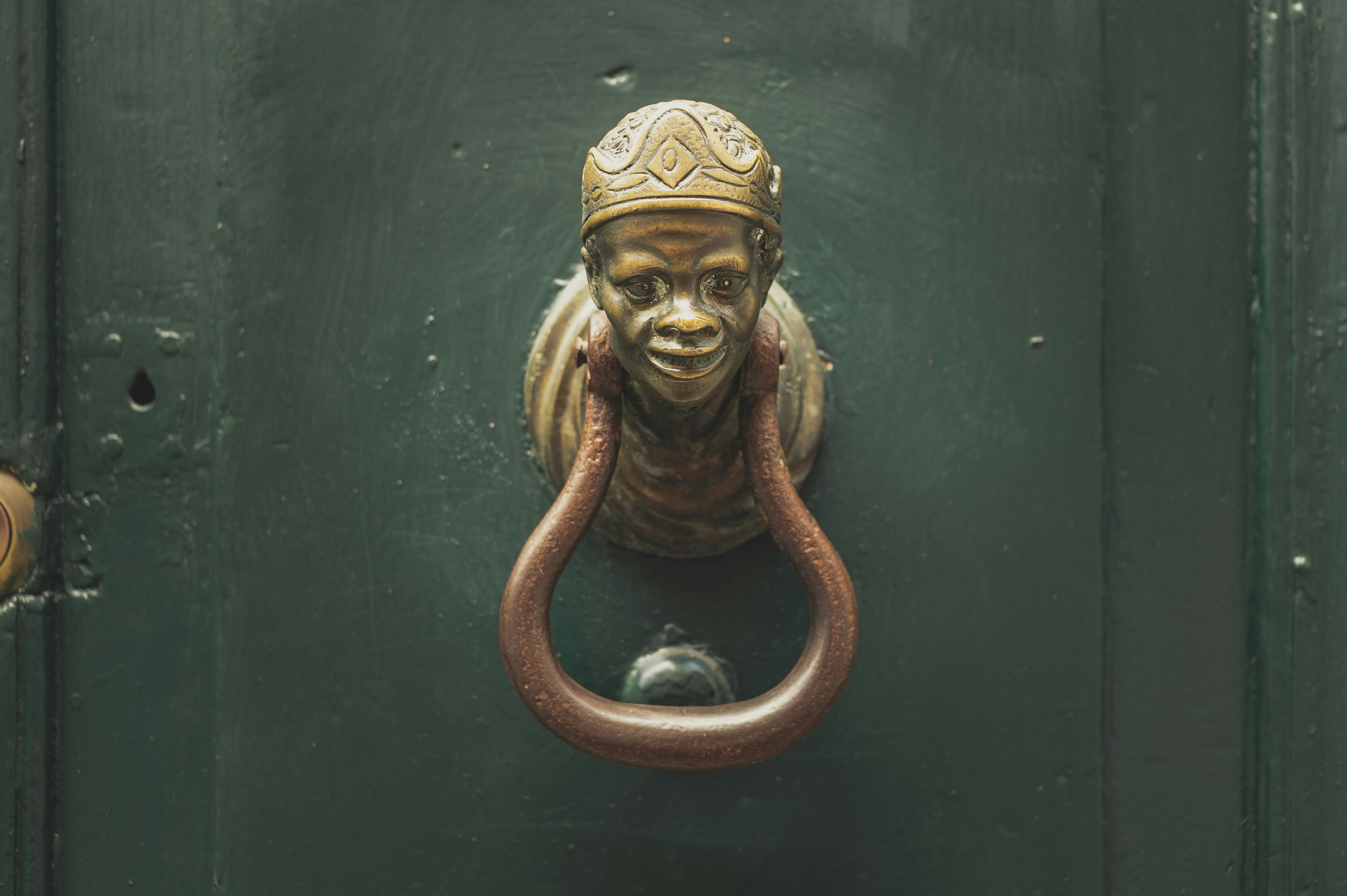 The Guard’s Loop: A Bronze Face on a Green Door