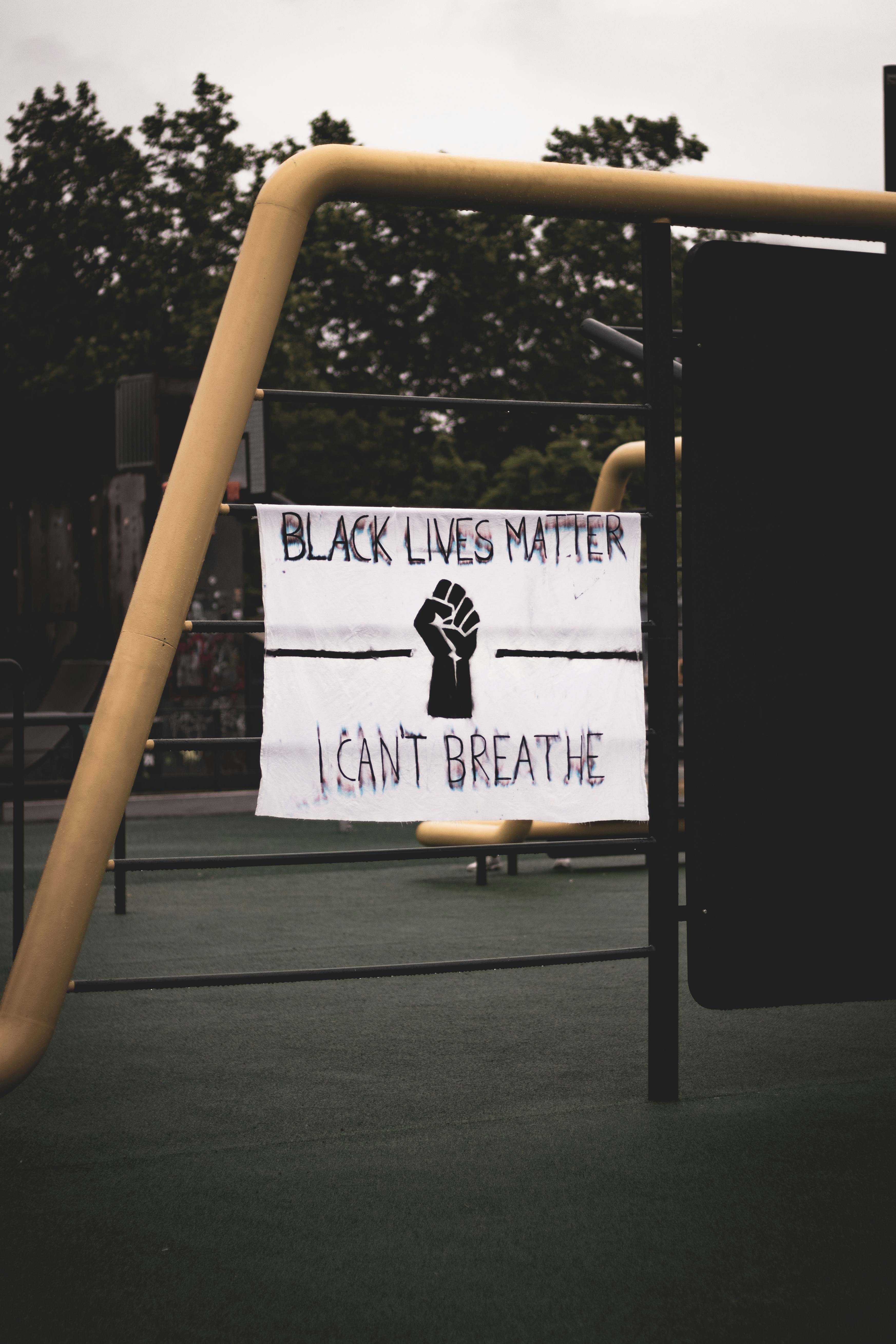 Banner of Resilience: Black Lives Matter on a Park Playground at Dusk