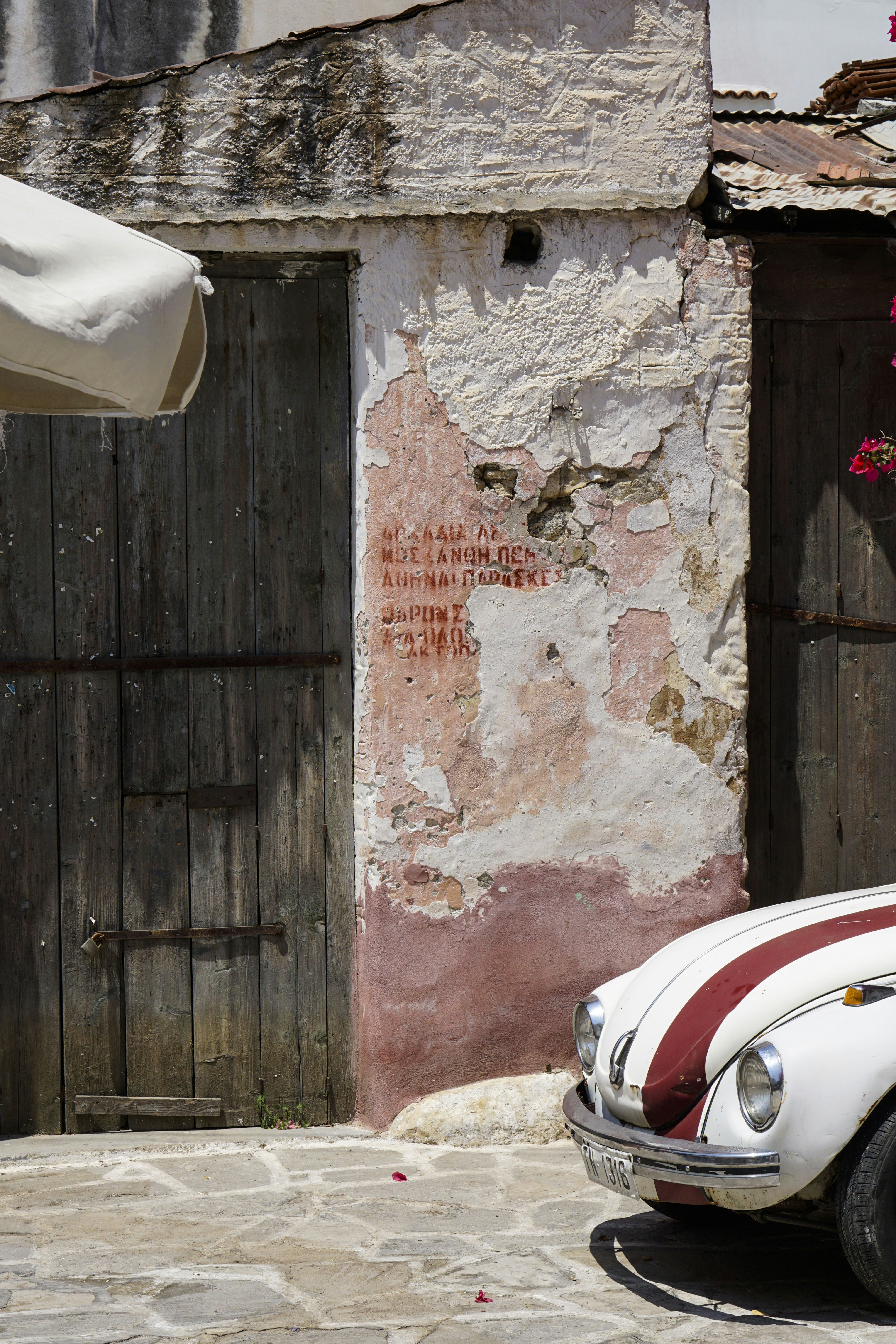 Weathered Plaster, Dark Doors, and a Vintage Beetle in a Sunlit Courtyard