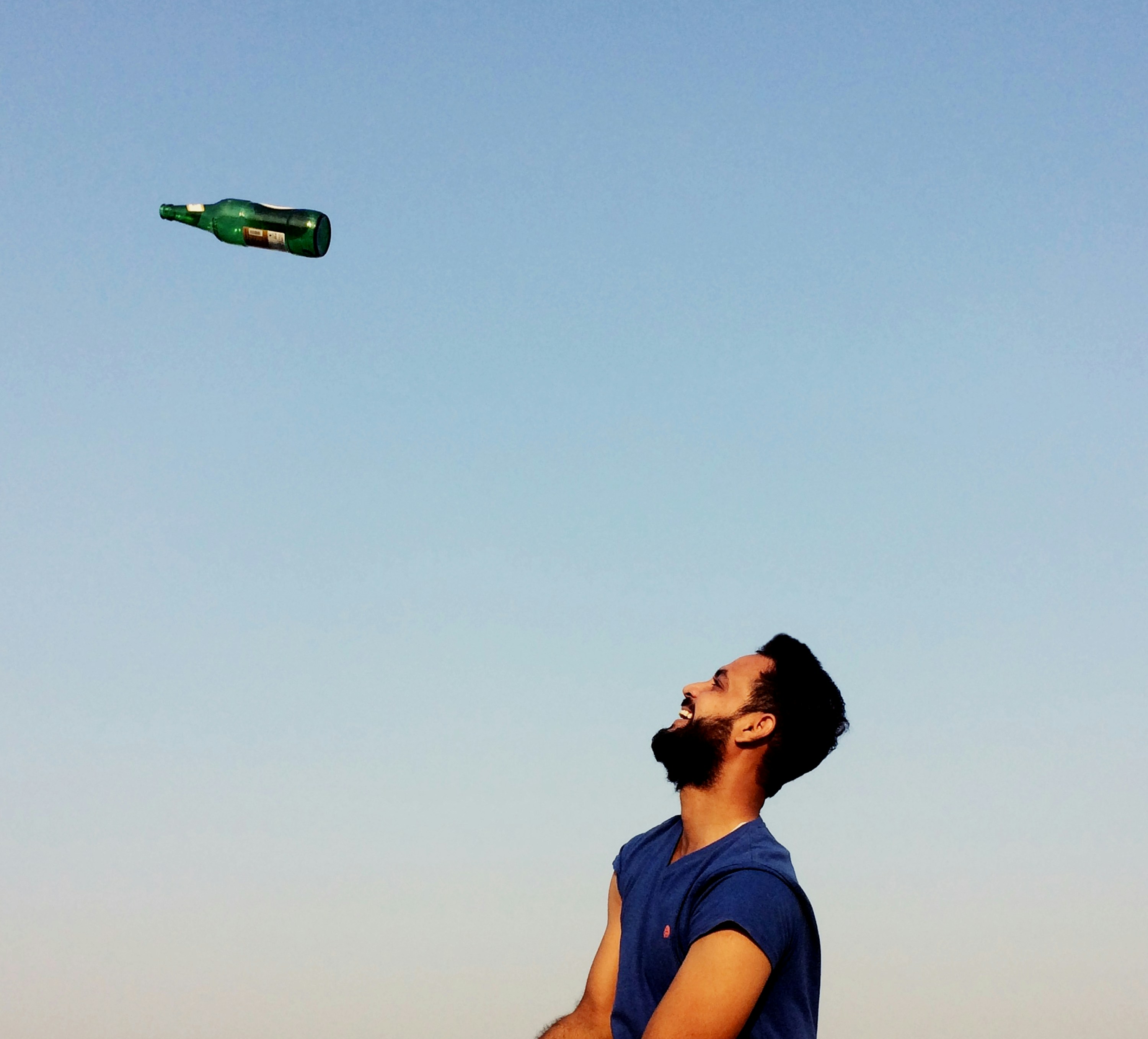Man playing with a beer bottle.