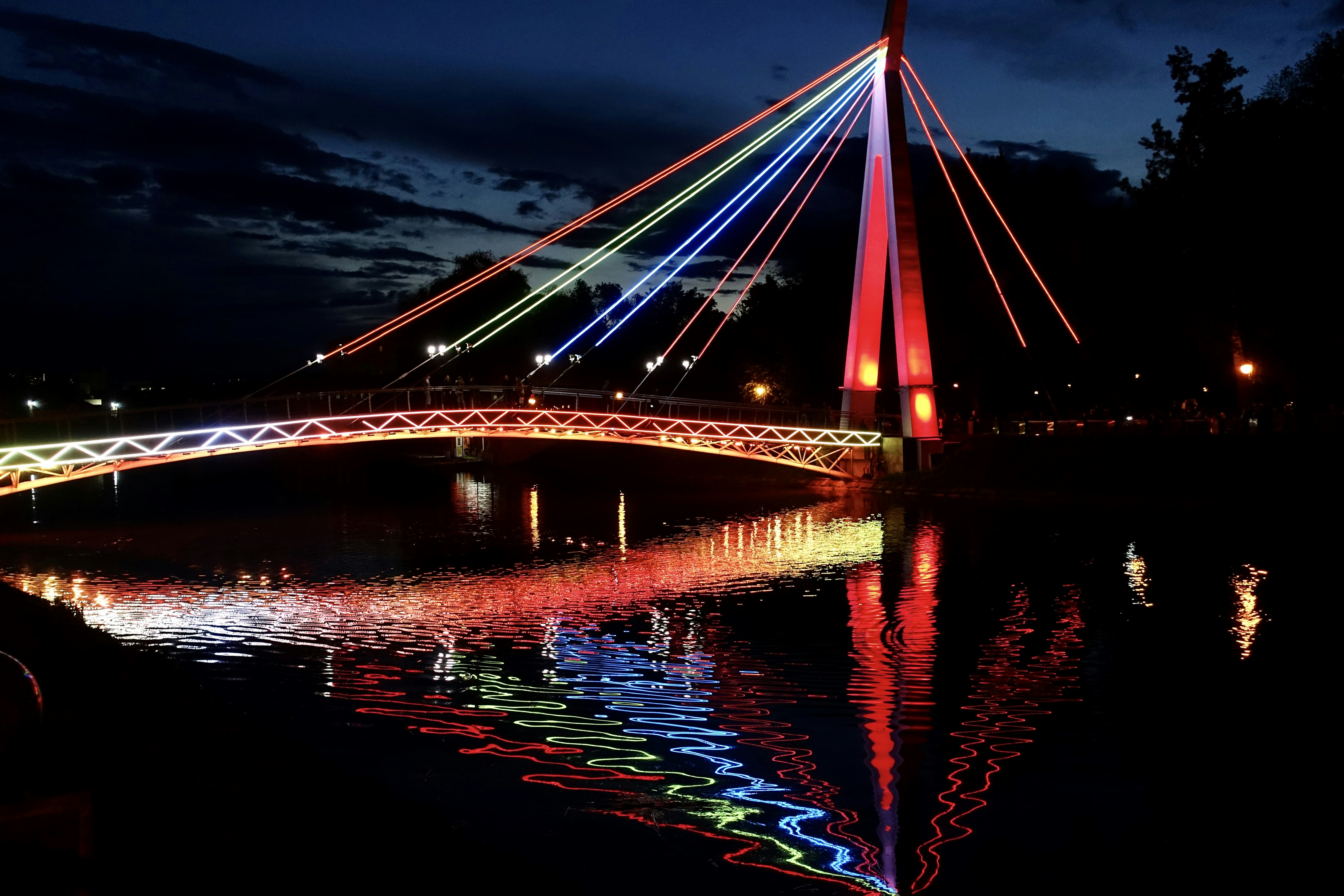 red bridge with lights during night time
