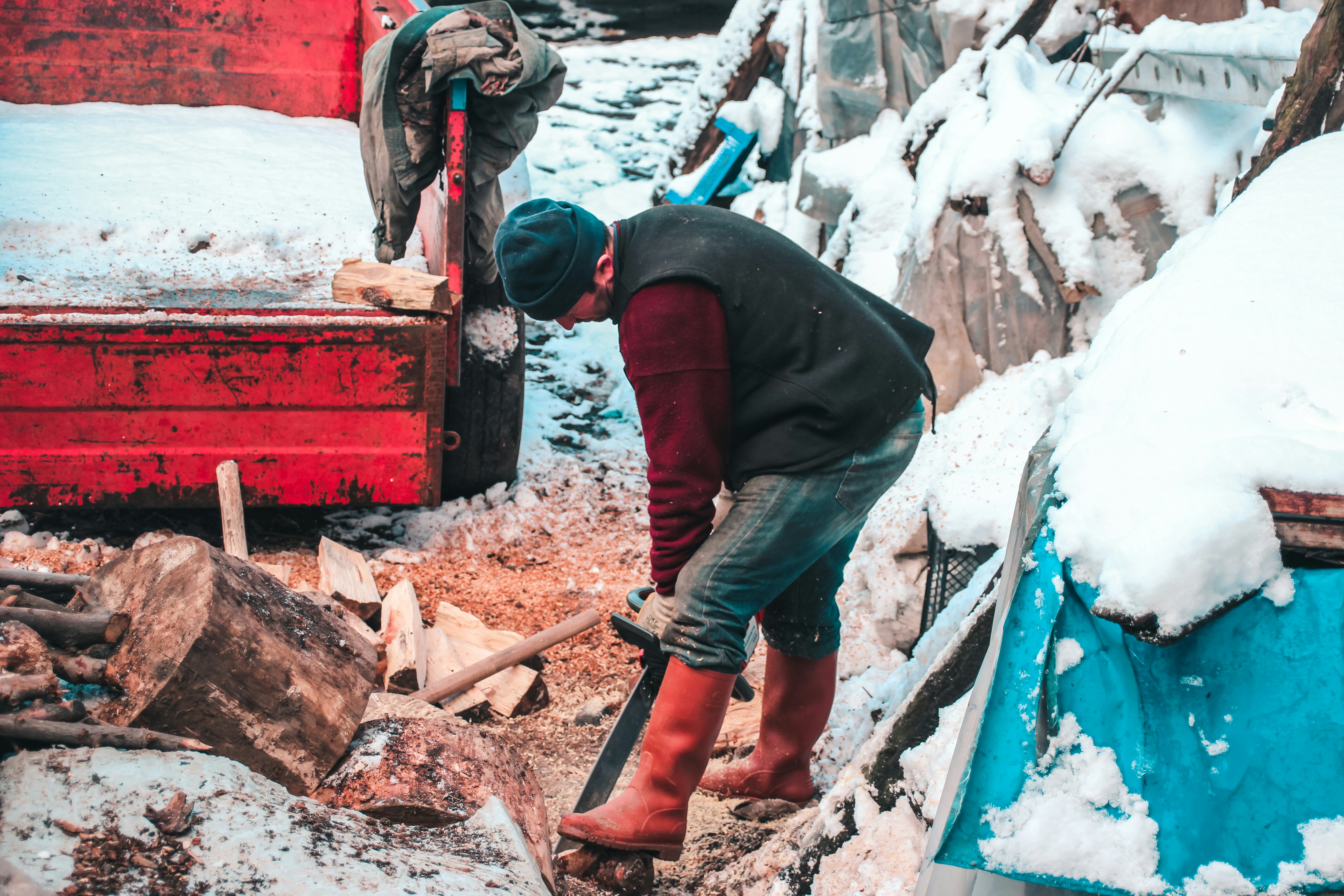 Snowbound Lumberjack: The Worker Bent at the Log Pile
