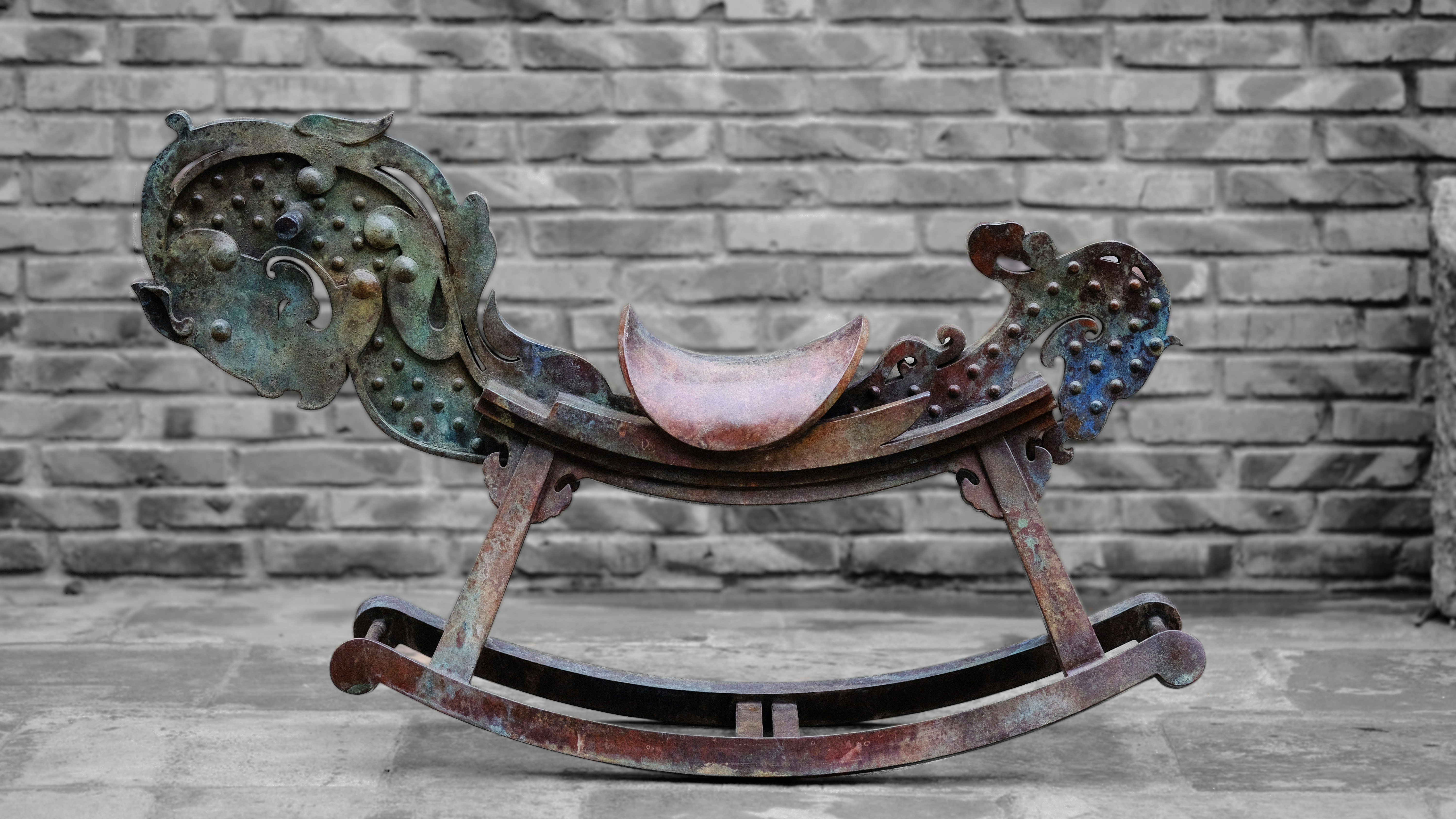 Rust and Ridges: An Antique Rocking Sleigh Resting by a Weathered Brick Wall