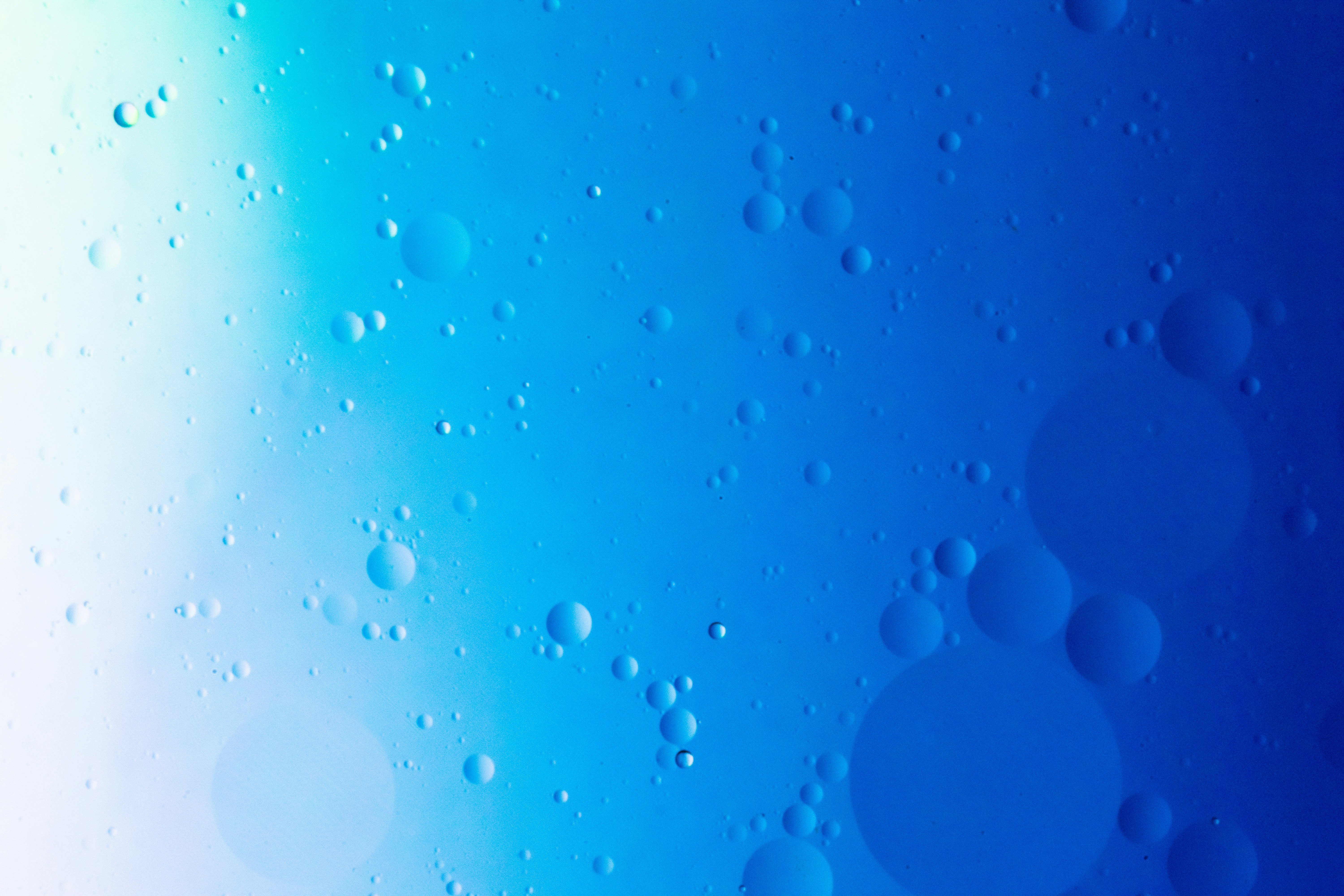Abstract illustration featuring a gradient blue background with various sizes of bubbles creating a serene underwater atmosphere.