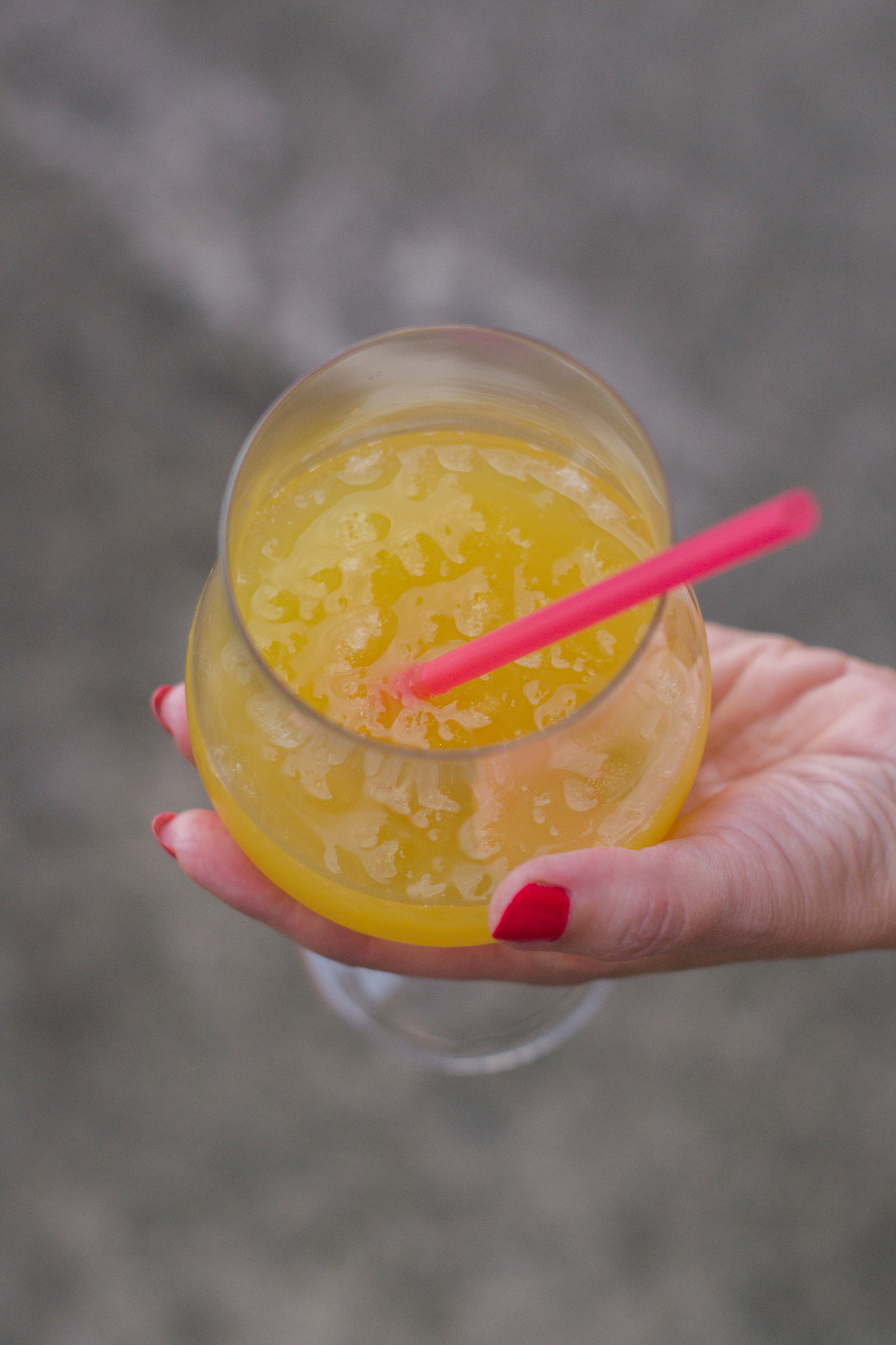 Sunlit Citrus in Hand: A Pink-Straw Moment