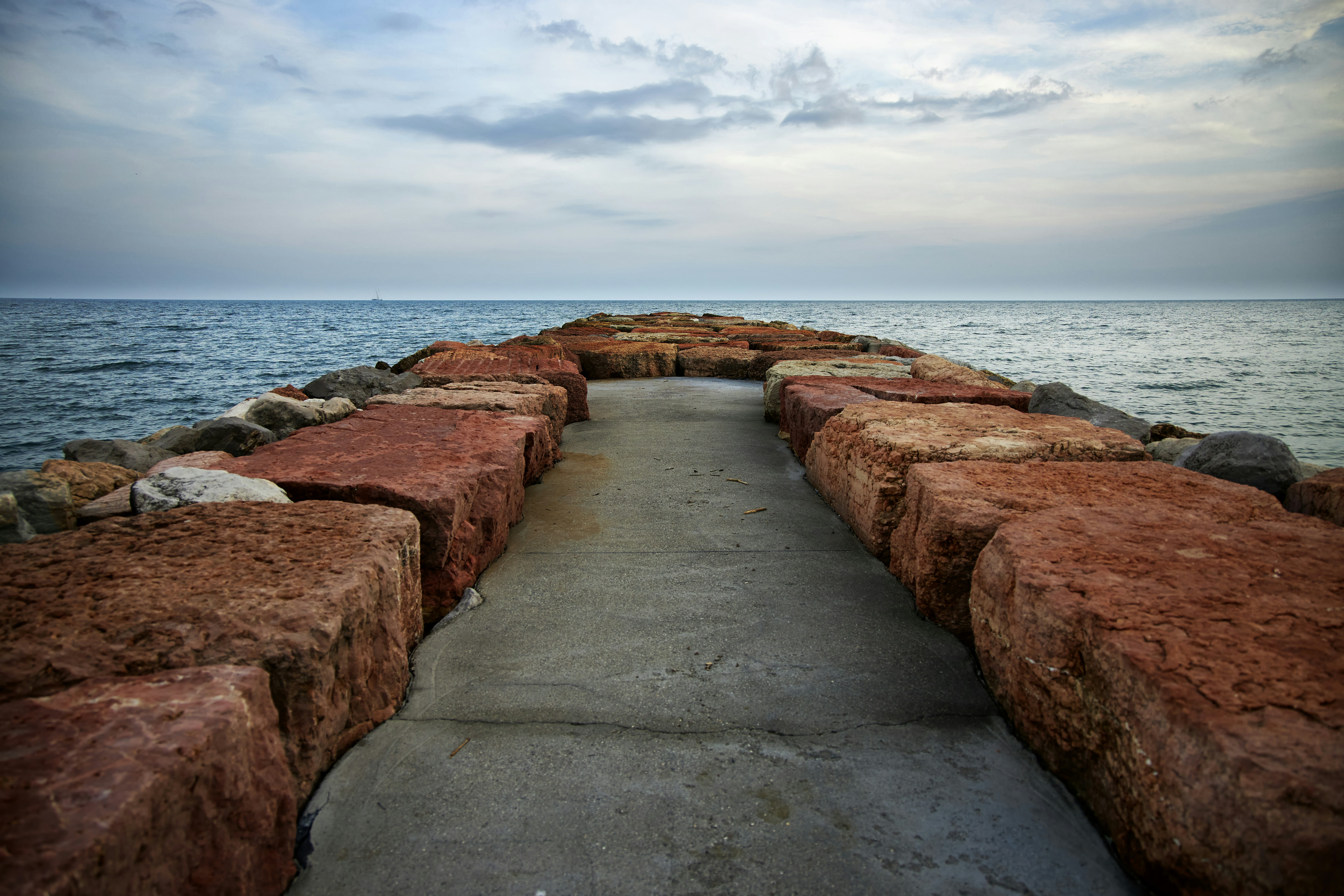 Red Rock Jetty Reaching the Quiet Sea Horizon