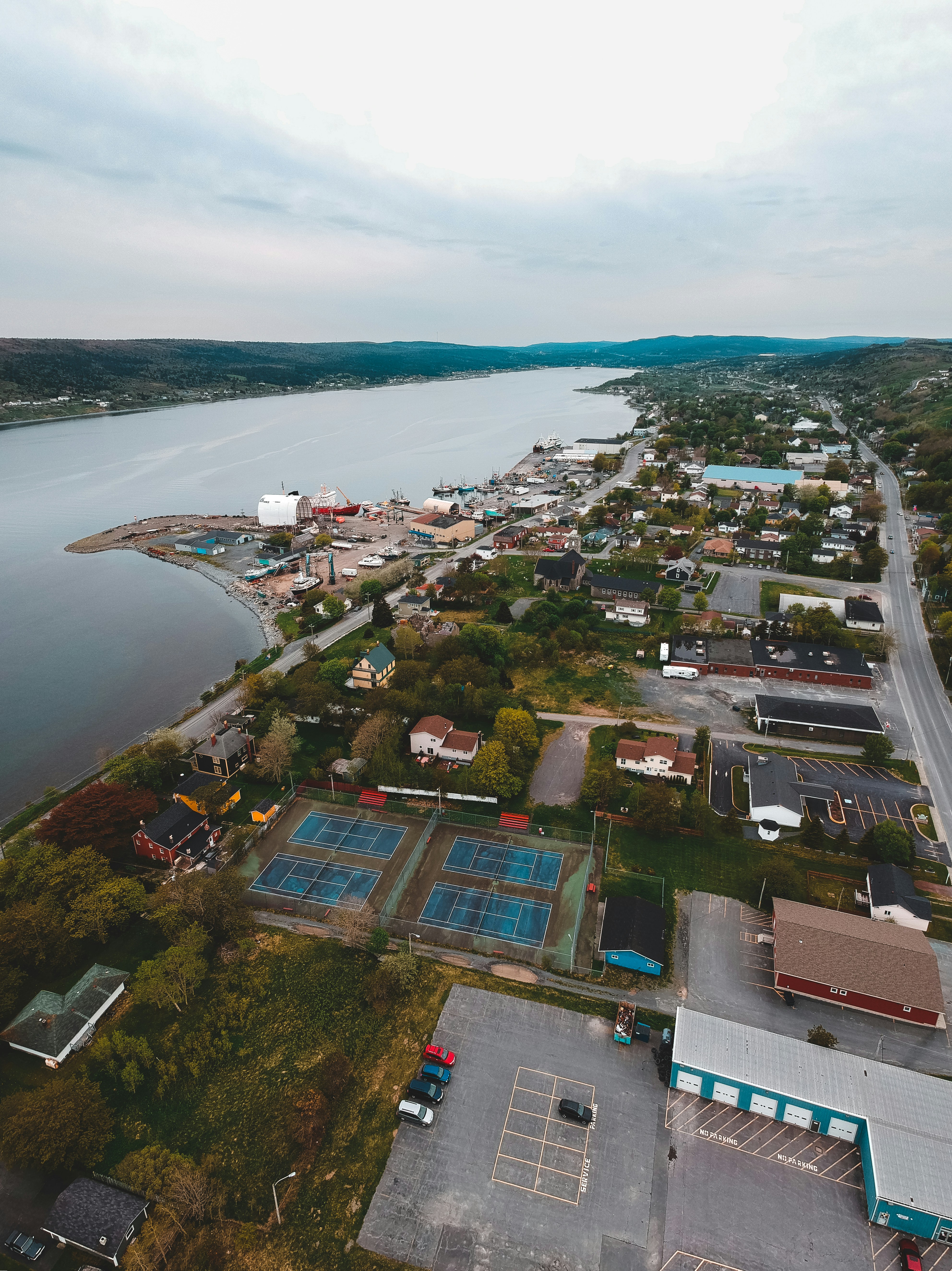 Aerial View of a Riverside Town: Docks, Parcels, and Courts