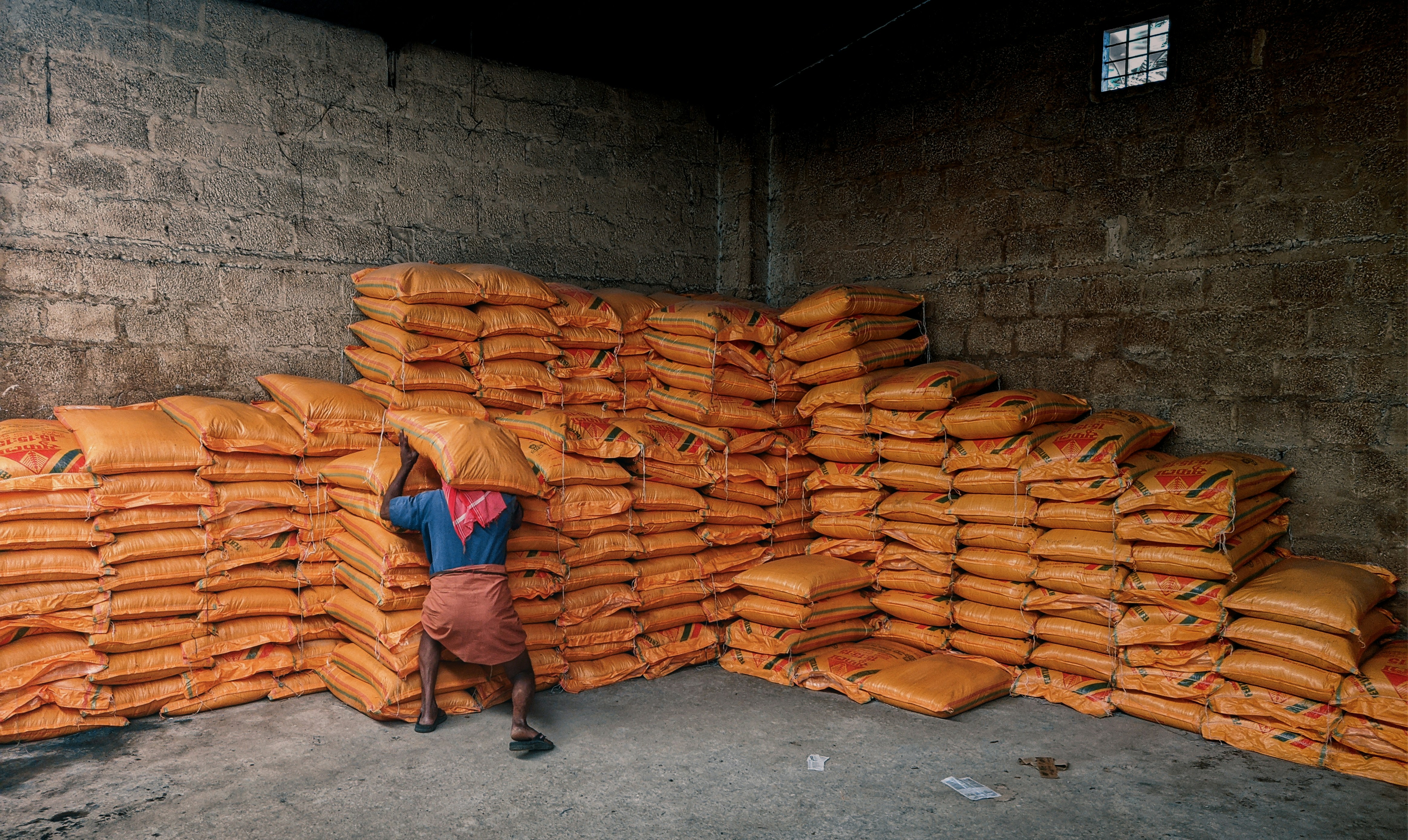 Person in blue shirt and black pants sitting on brown wooden chair ...