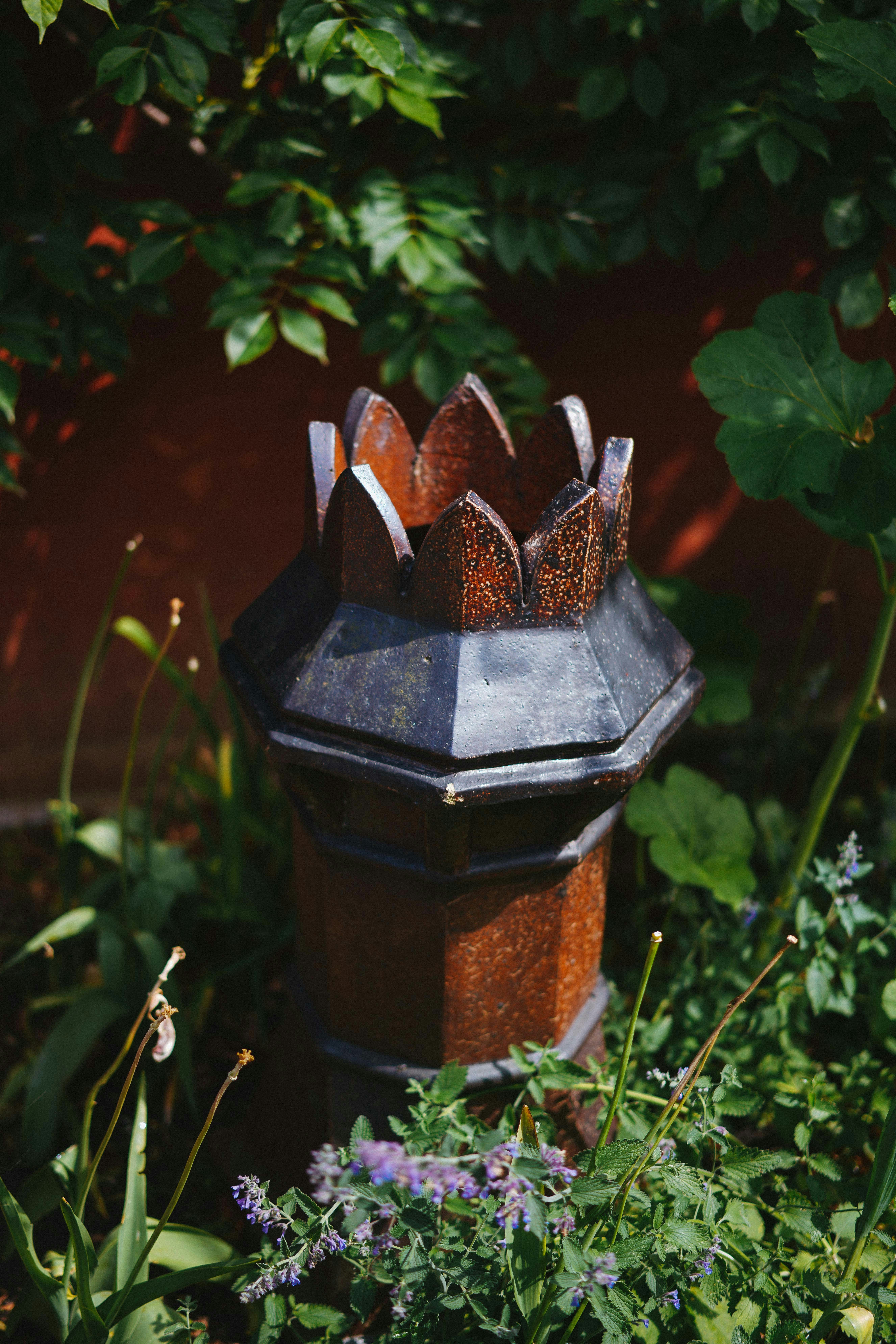 Crown of Rust: A Garden Lantern Amid Greenery and Lavender