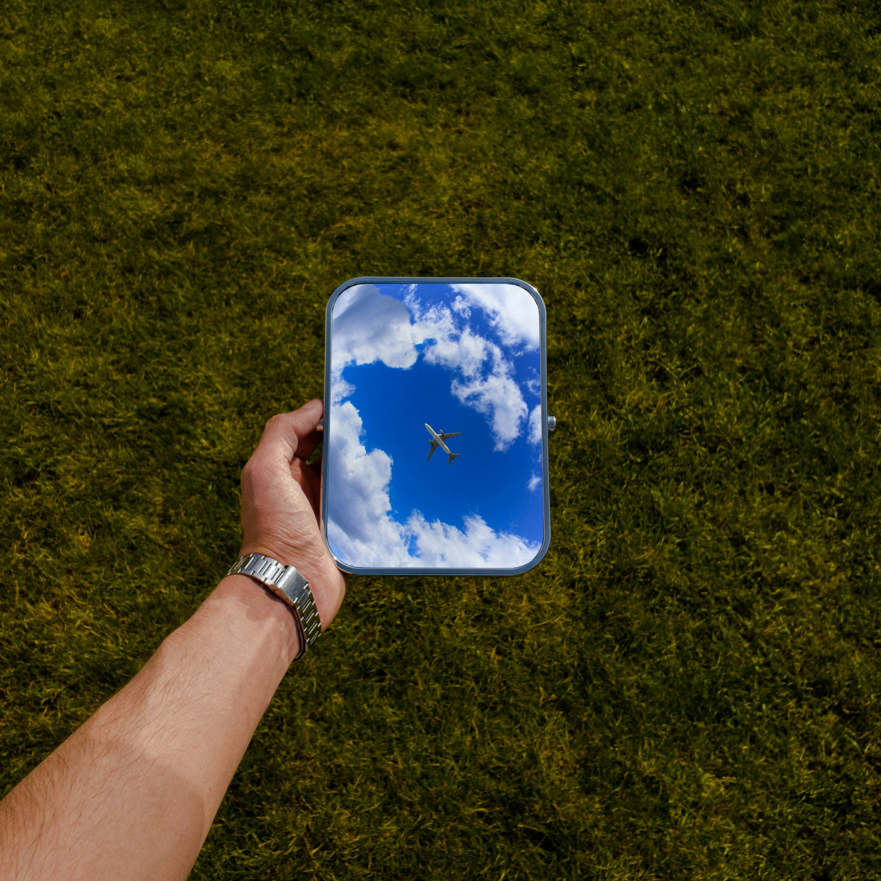 person holding blue and white floral tray