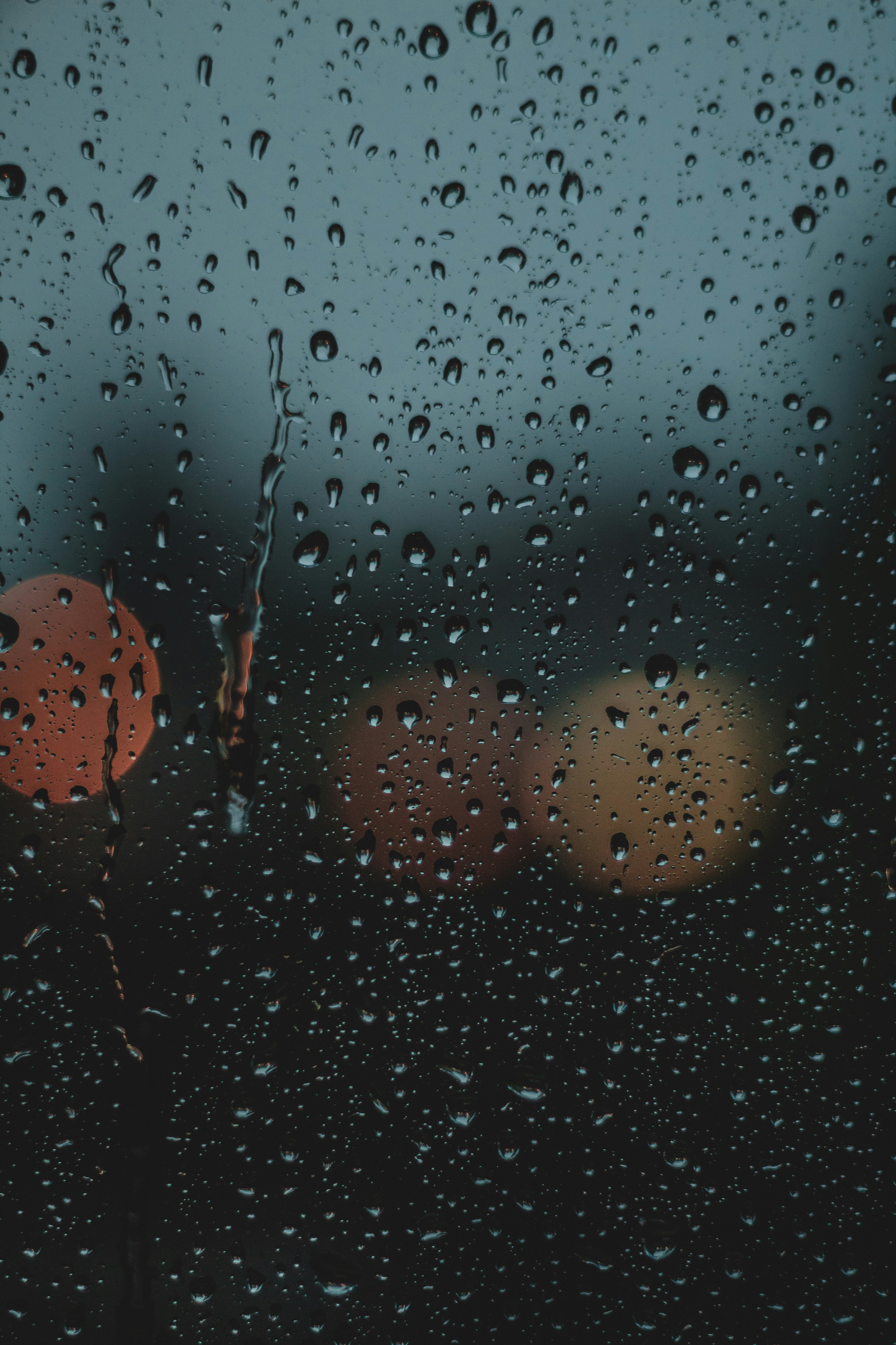 Veiled Neon Through Rain-Pocked Glass