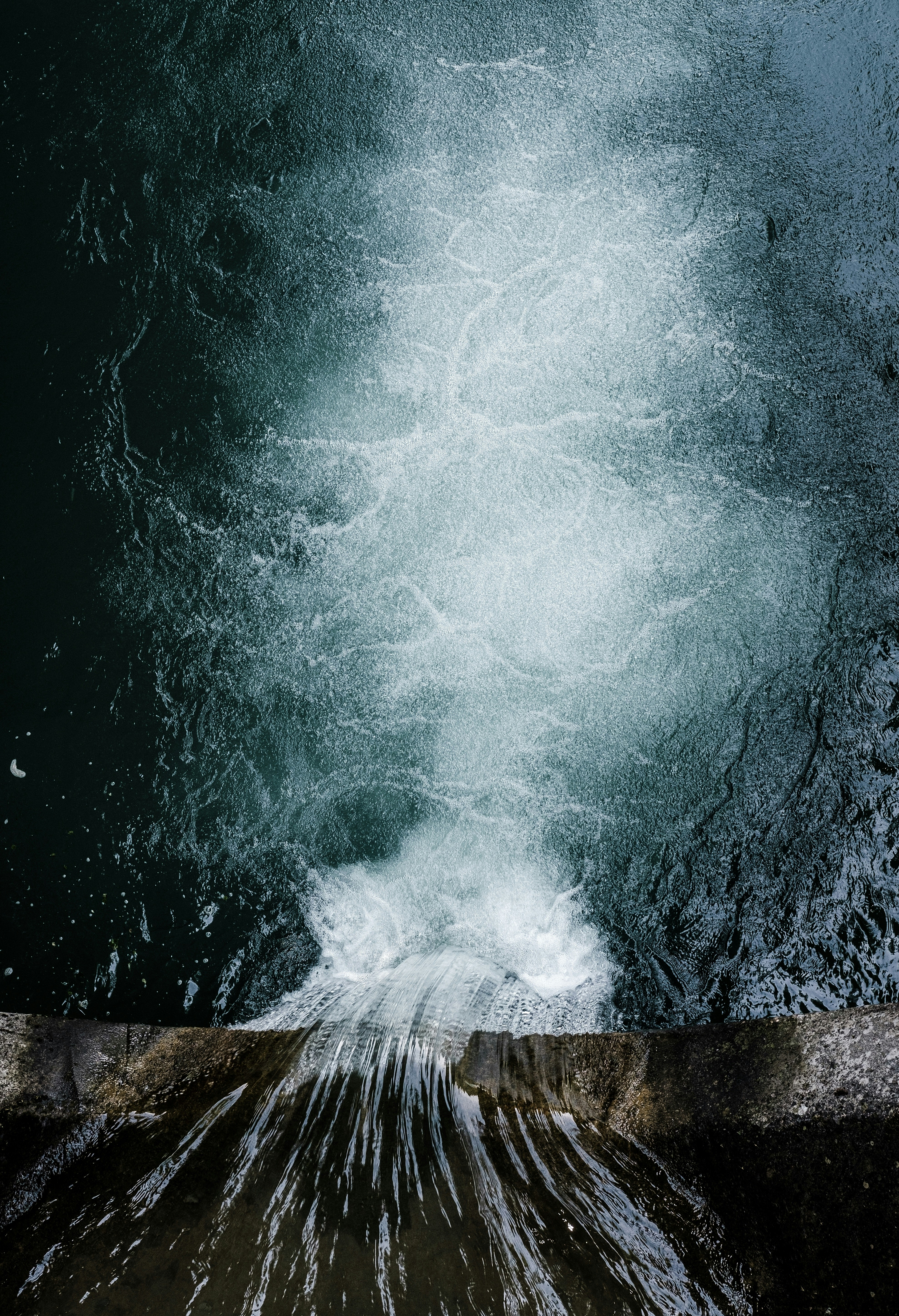 Lip of the Dam: White Surge Over Concrete Spillway