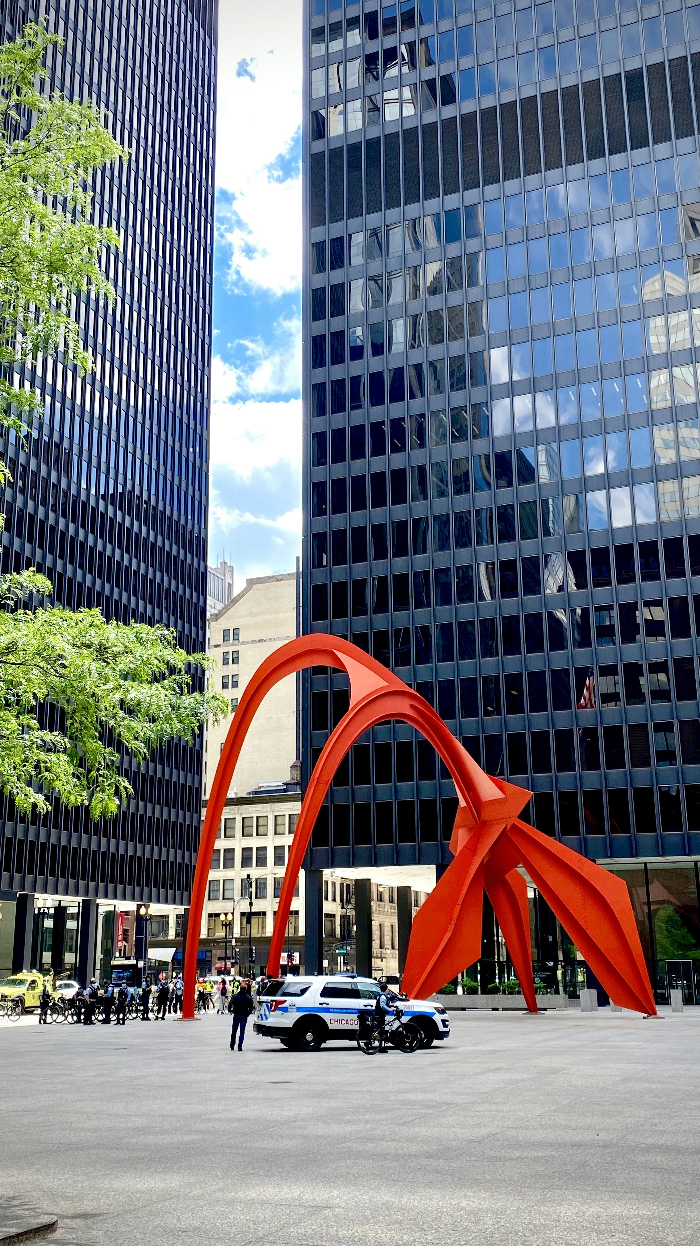 Crimson Arch Between Glass Giants: A City Sculpture Scene