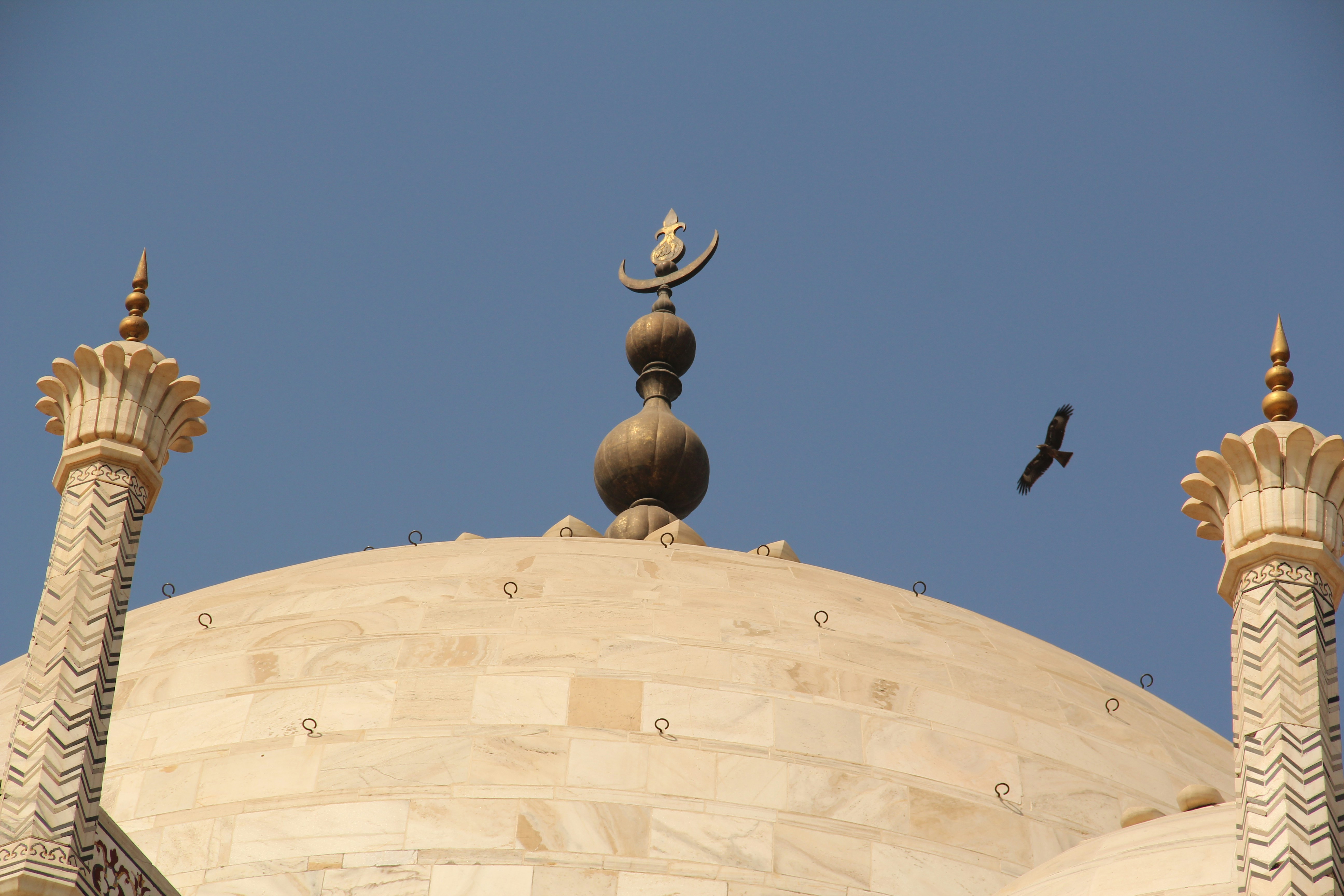 Crescent Crown Over a Marble Dome Against a Clear Blue Sky