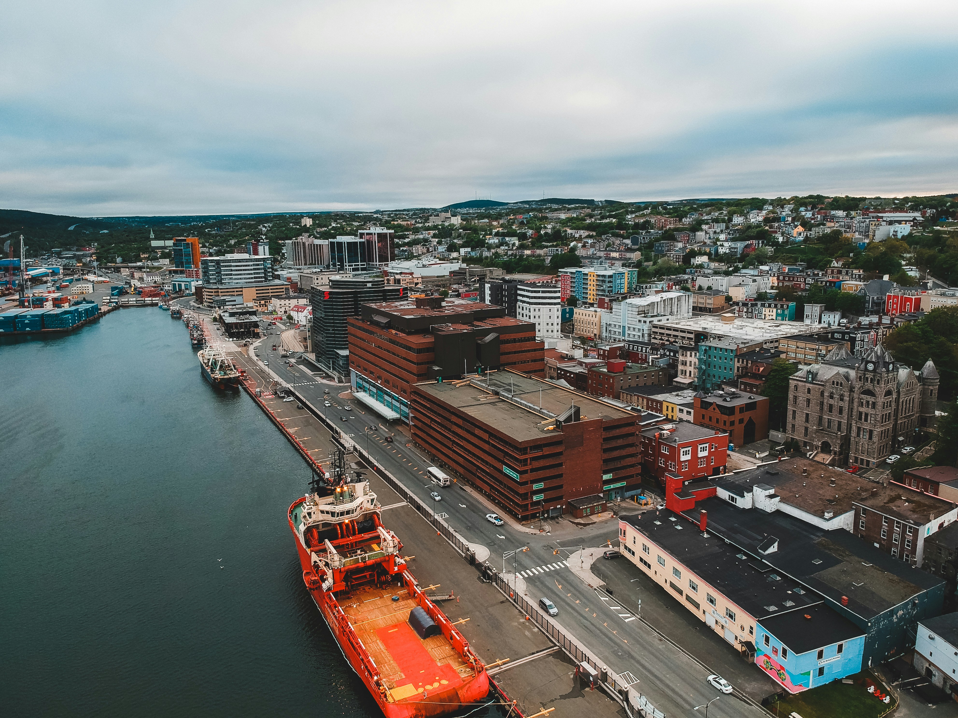 Orange Workboat at the Edge of a Colorful Harbor Town
