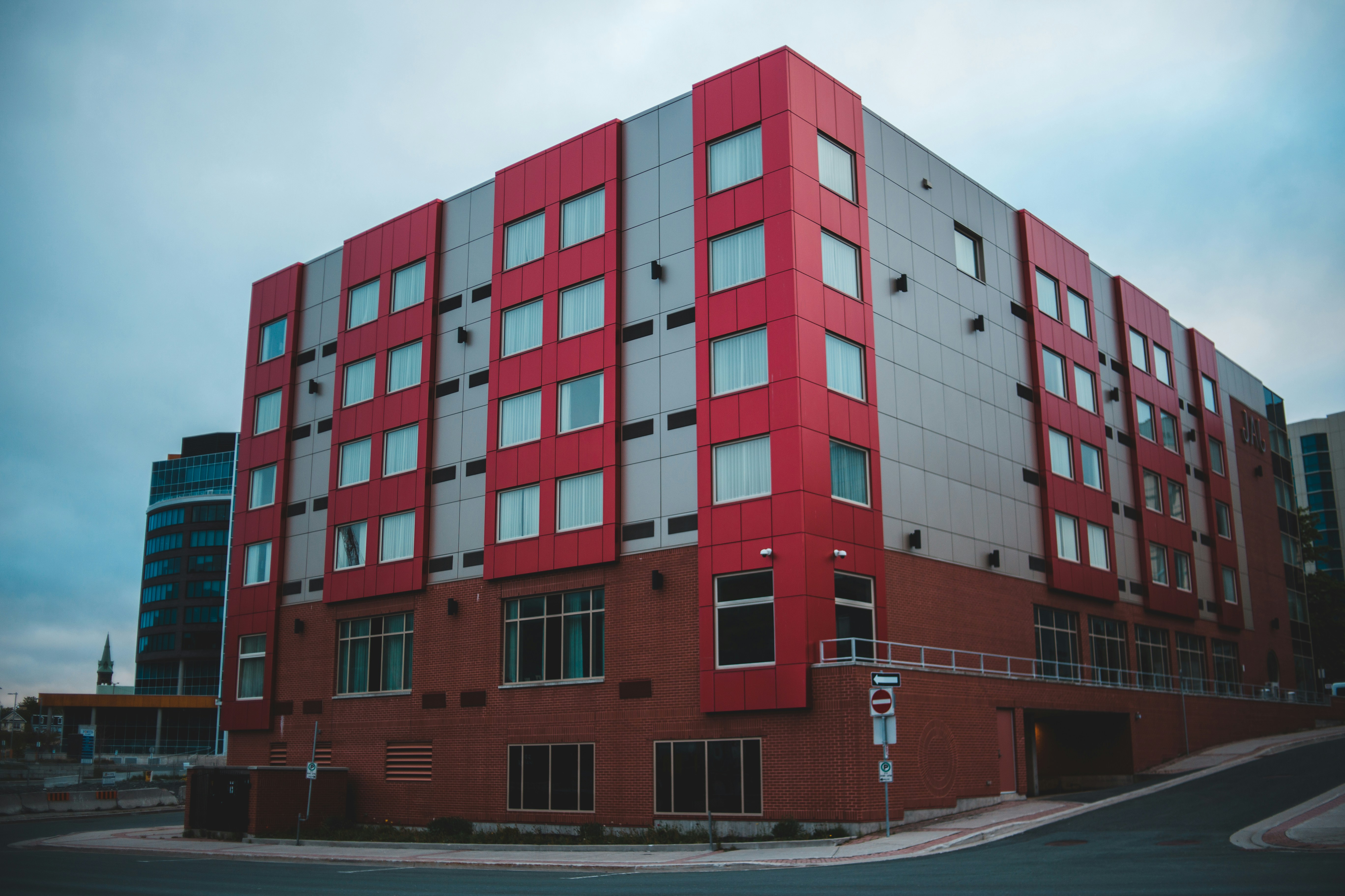 Crimson Facade on a Street Corner: Modern Urban Geometry