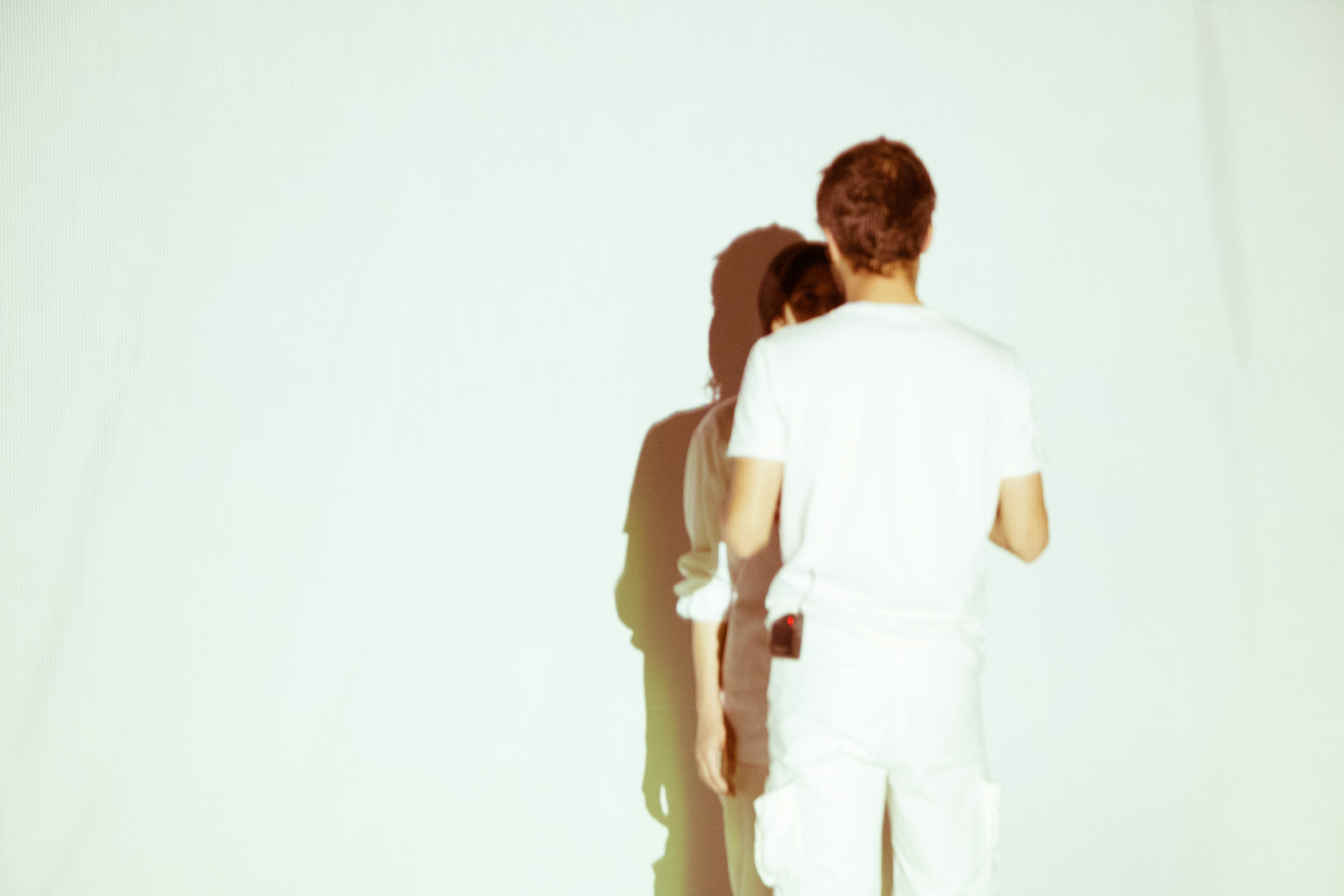 Shadow Confidants: White Ensemble in a Pale Projection