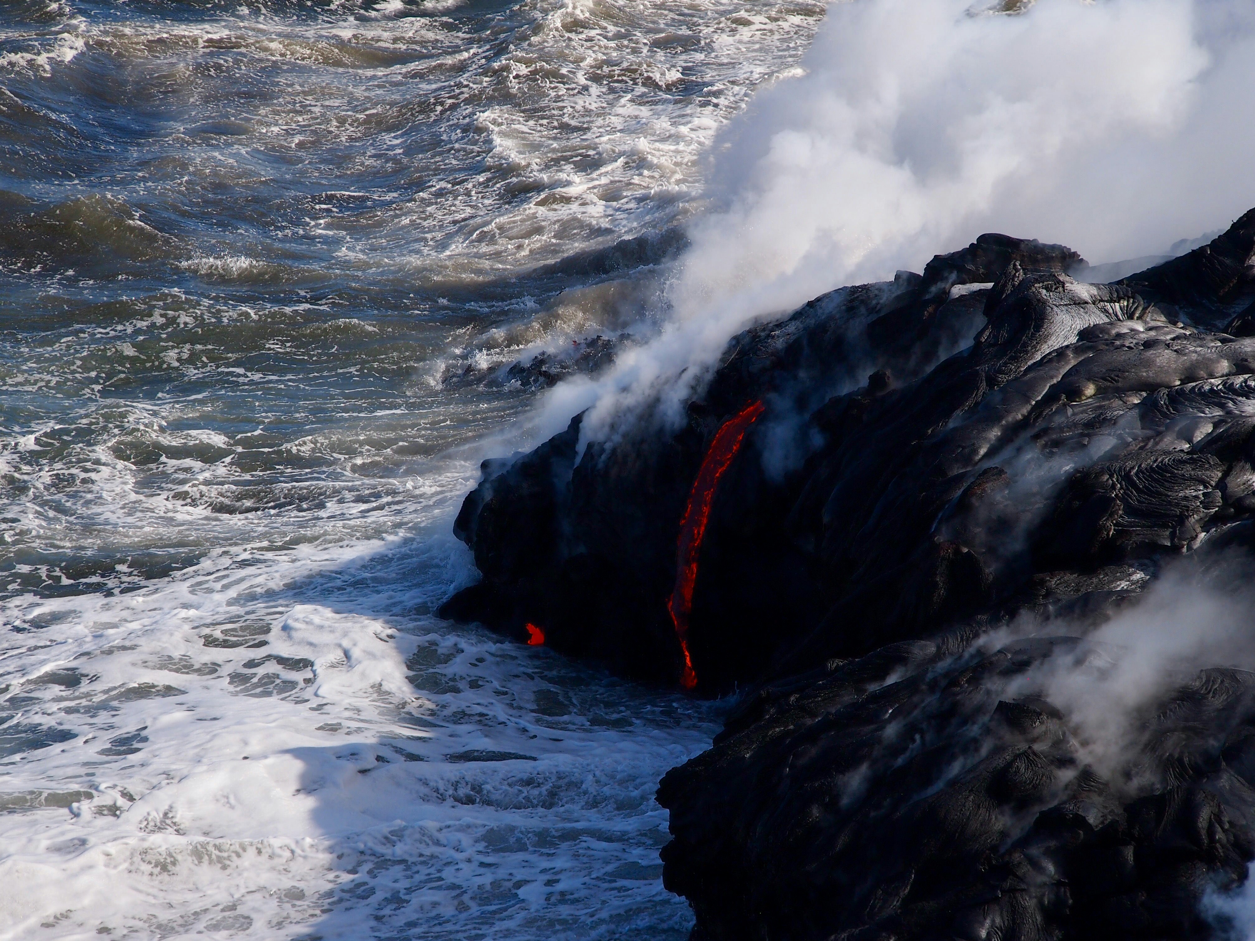 Crimson Vein in a Steam-Swept Lava Coast