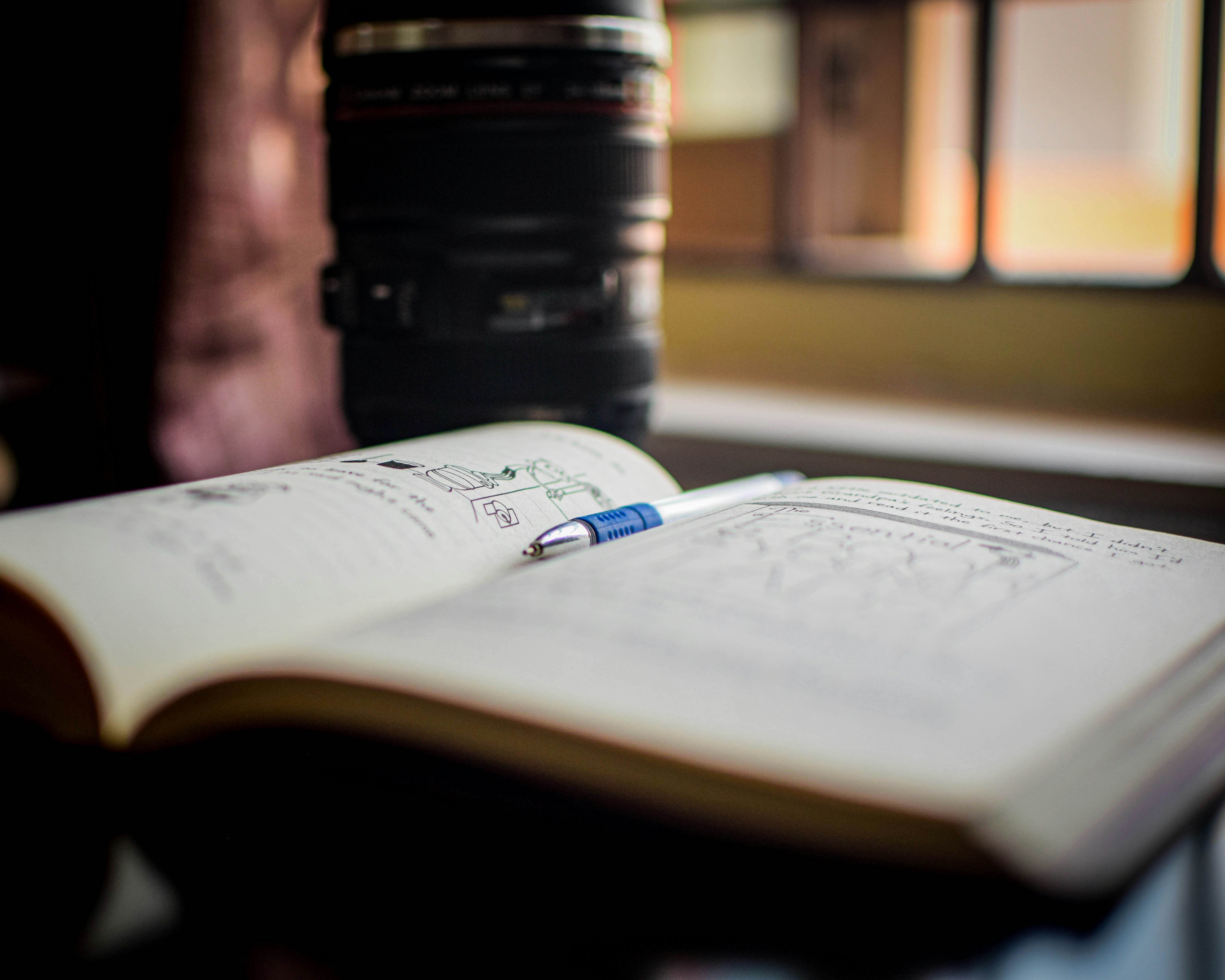 Whisper of Focus: A Pen on an Open Page Under a Softly Blurred Lens