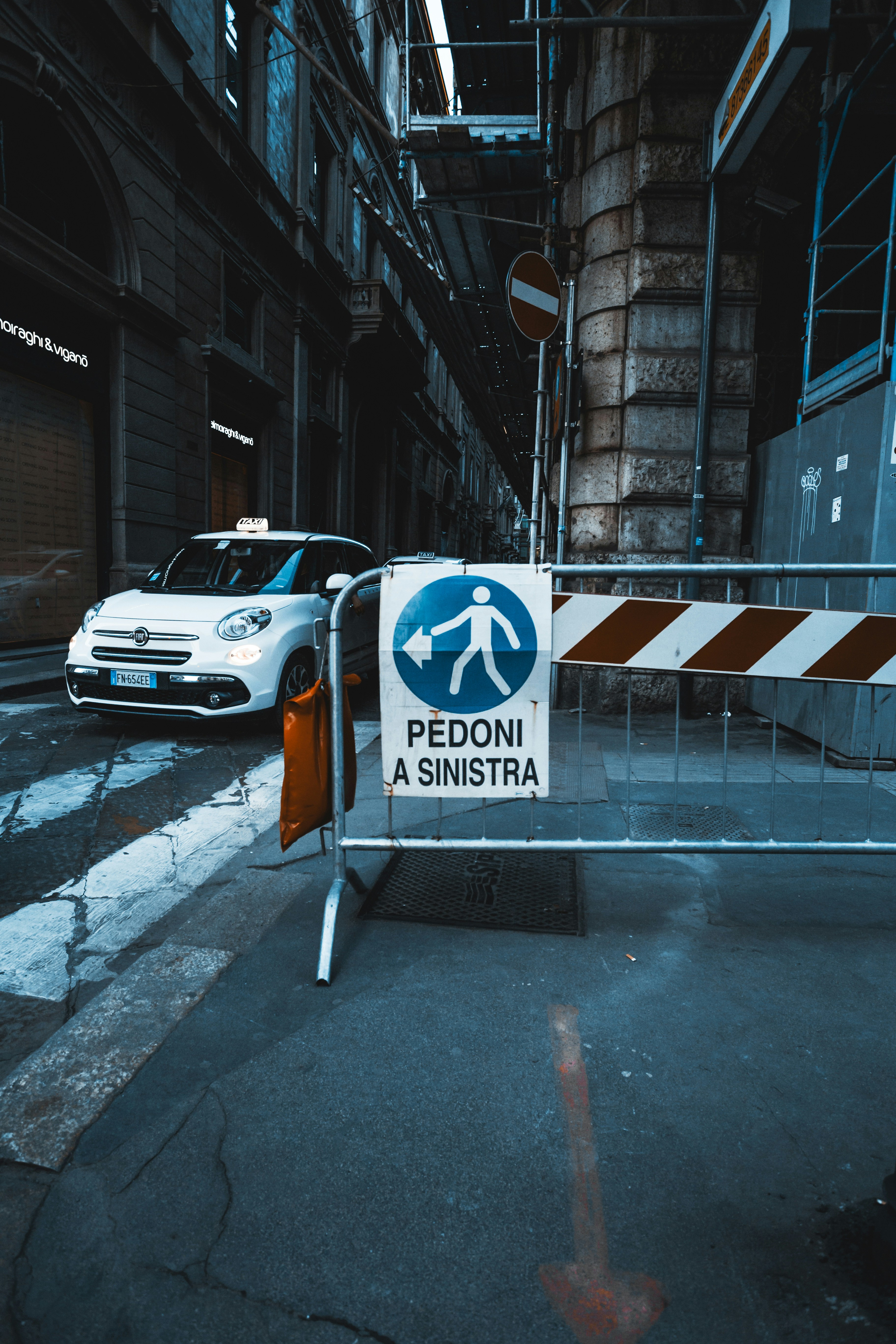 Blue Pedestrian Sign Anchoring a Narrow Italian Alley