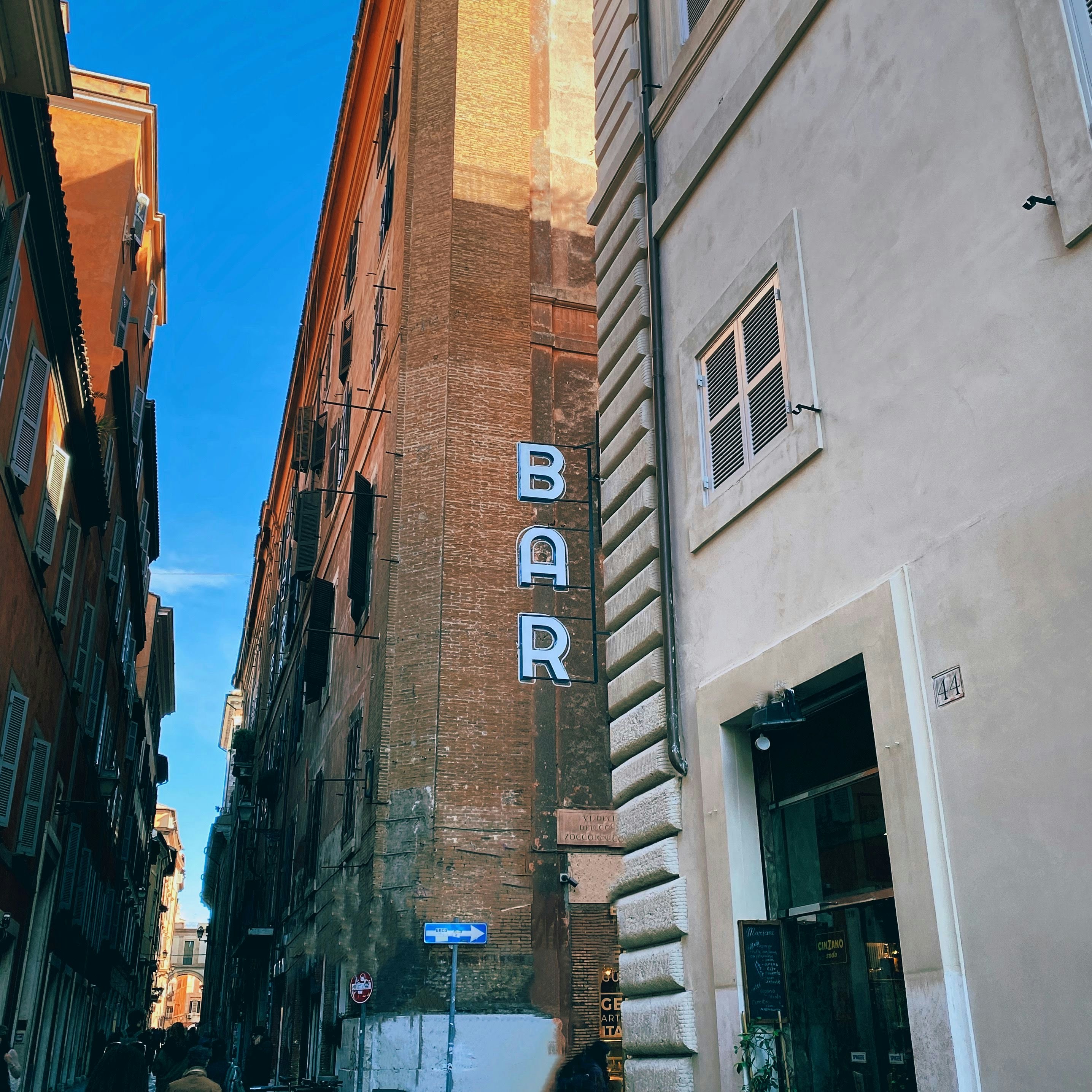 Neon BAR Sign Piercing a Narrow City Gable