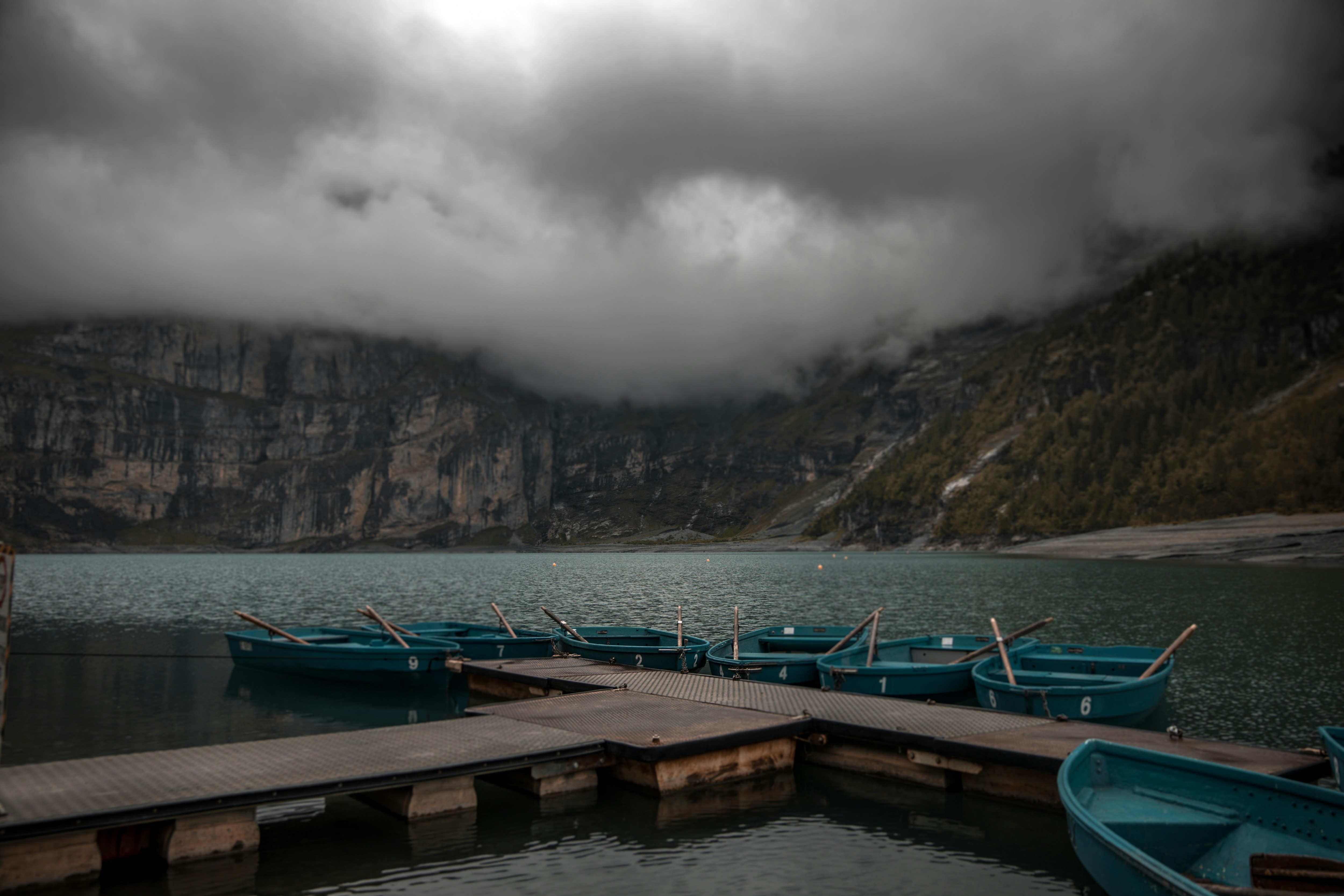 Teal Rowboats at a Mist-Wrapped Dock on a Quiet Lake