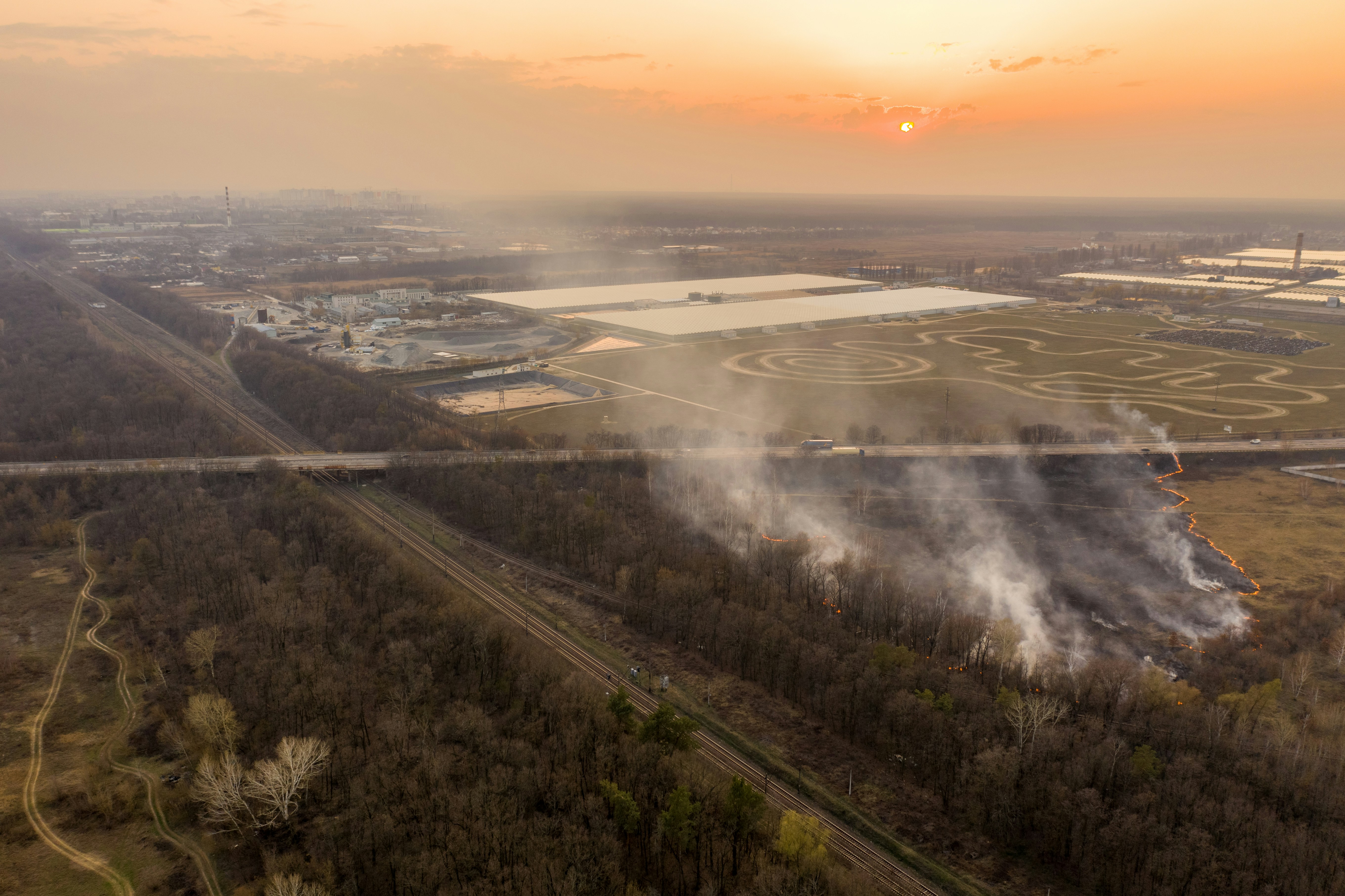 Smoke Over Industrial Grounds at Sunset