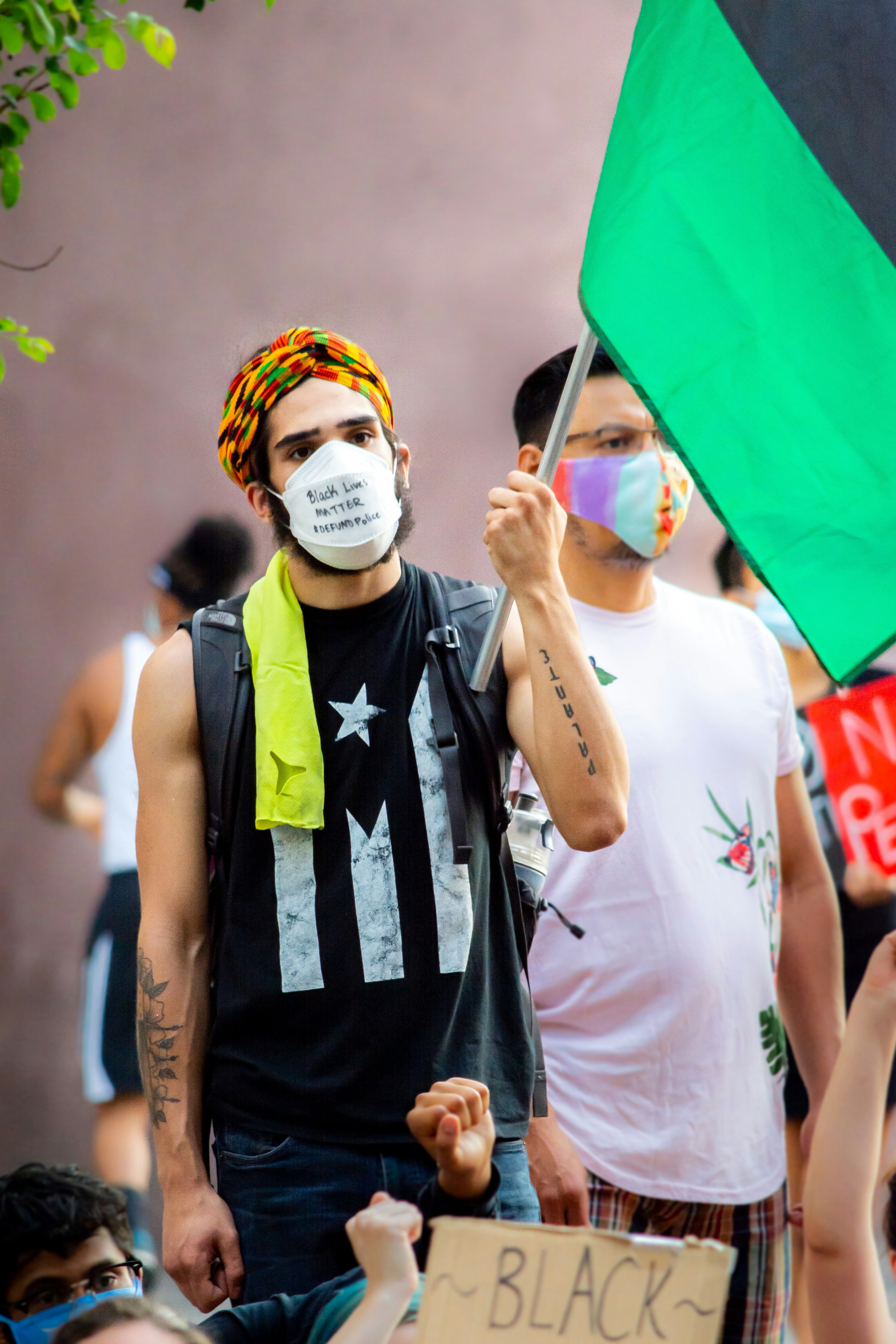 Center of Resolve: A Masked Protester with Flag in Focus