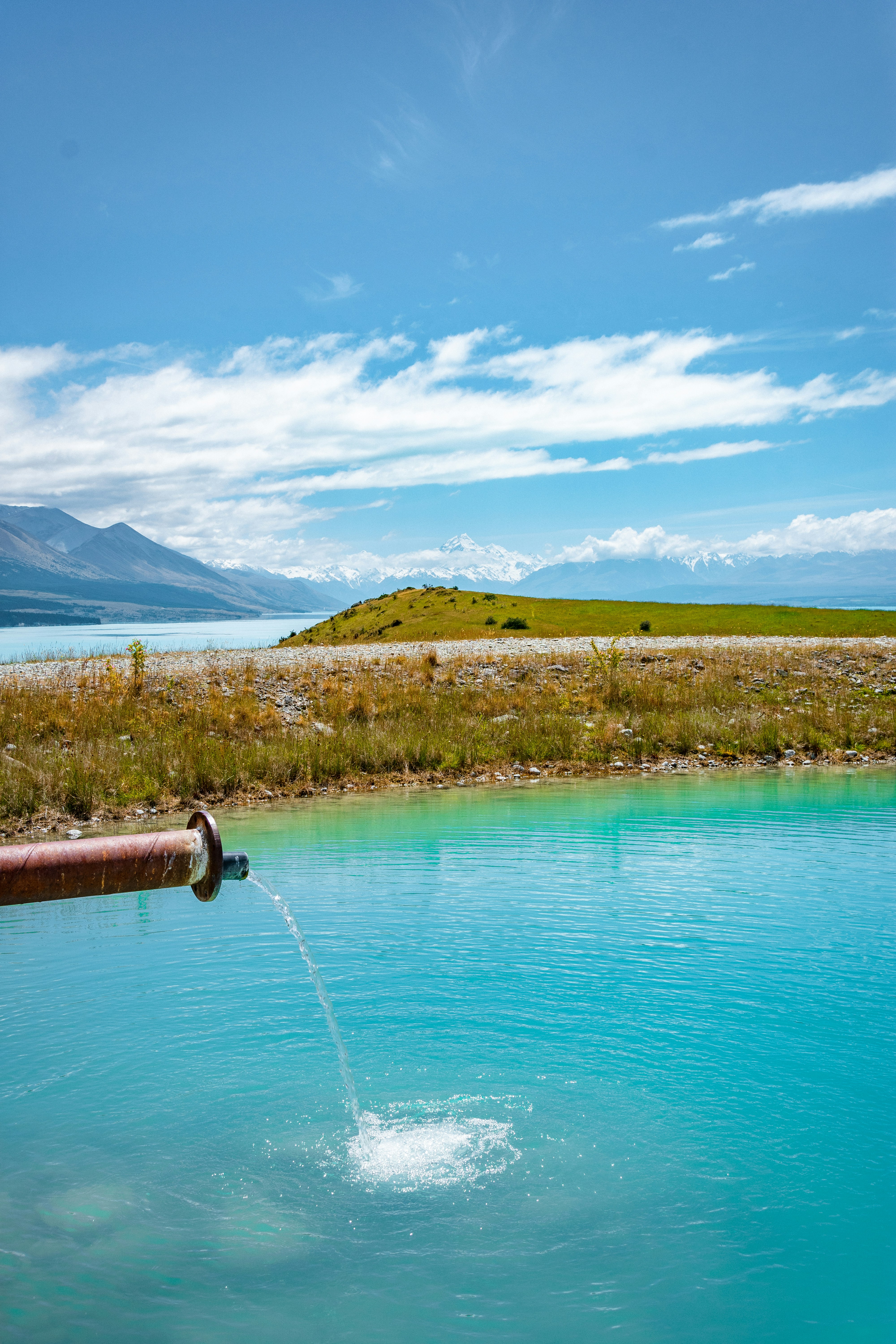 Emerald Spill: Turquoise Basin at the Edge of an Alpine Plain