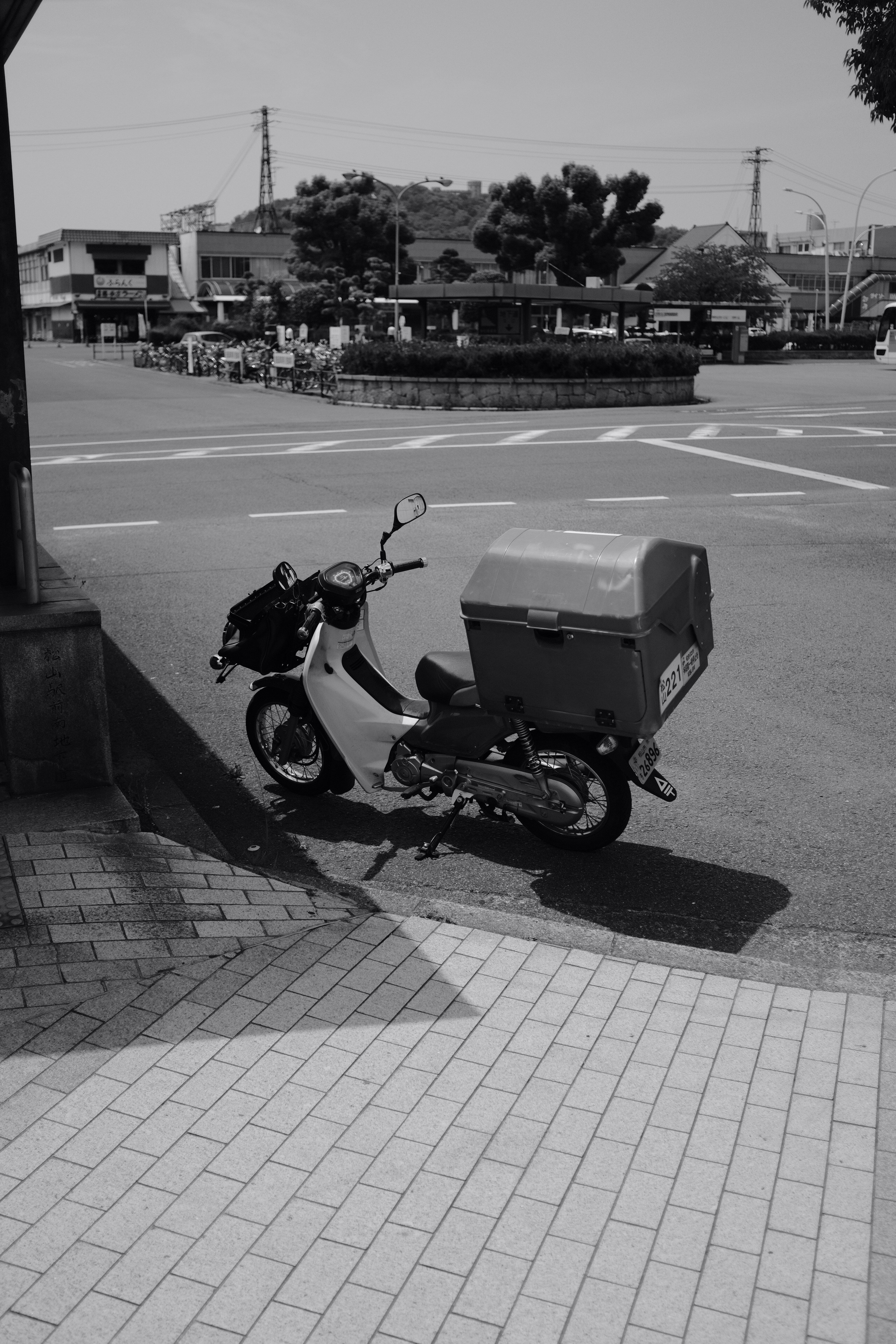 Midtown Courier: A Quiet Scooter Anchors the City Square