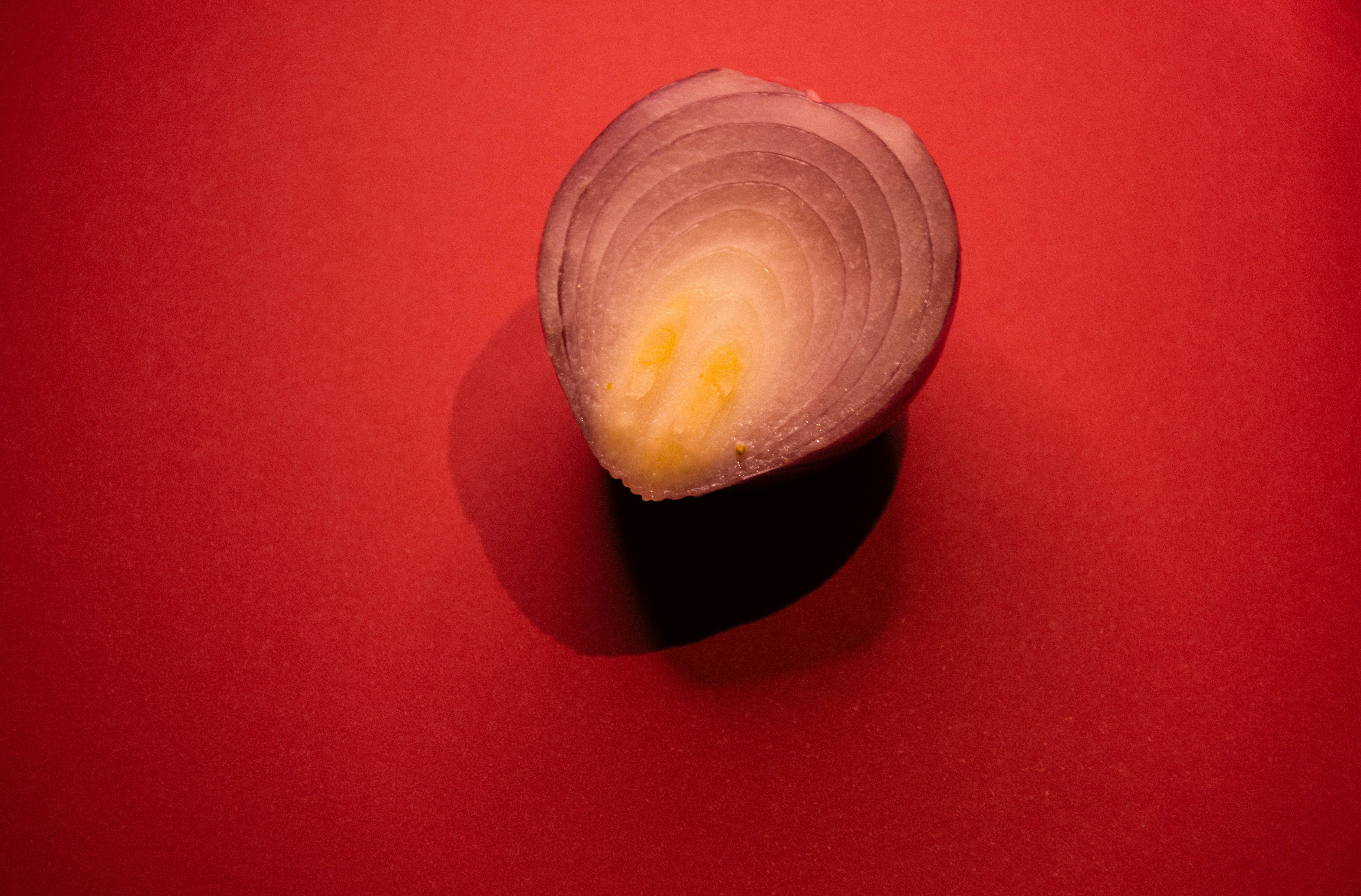 Violet Onion Cross-Section on a Scarlet Studio Surface