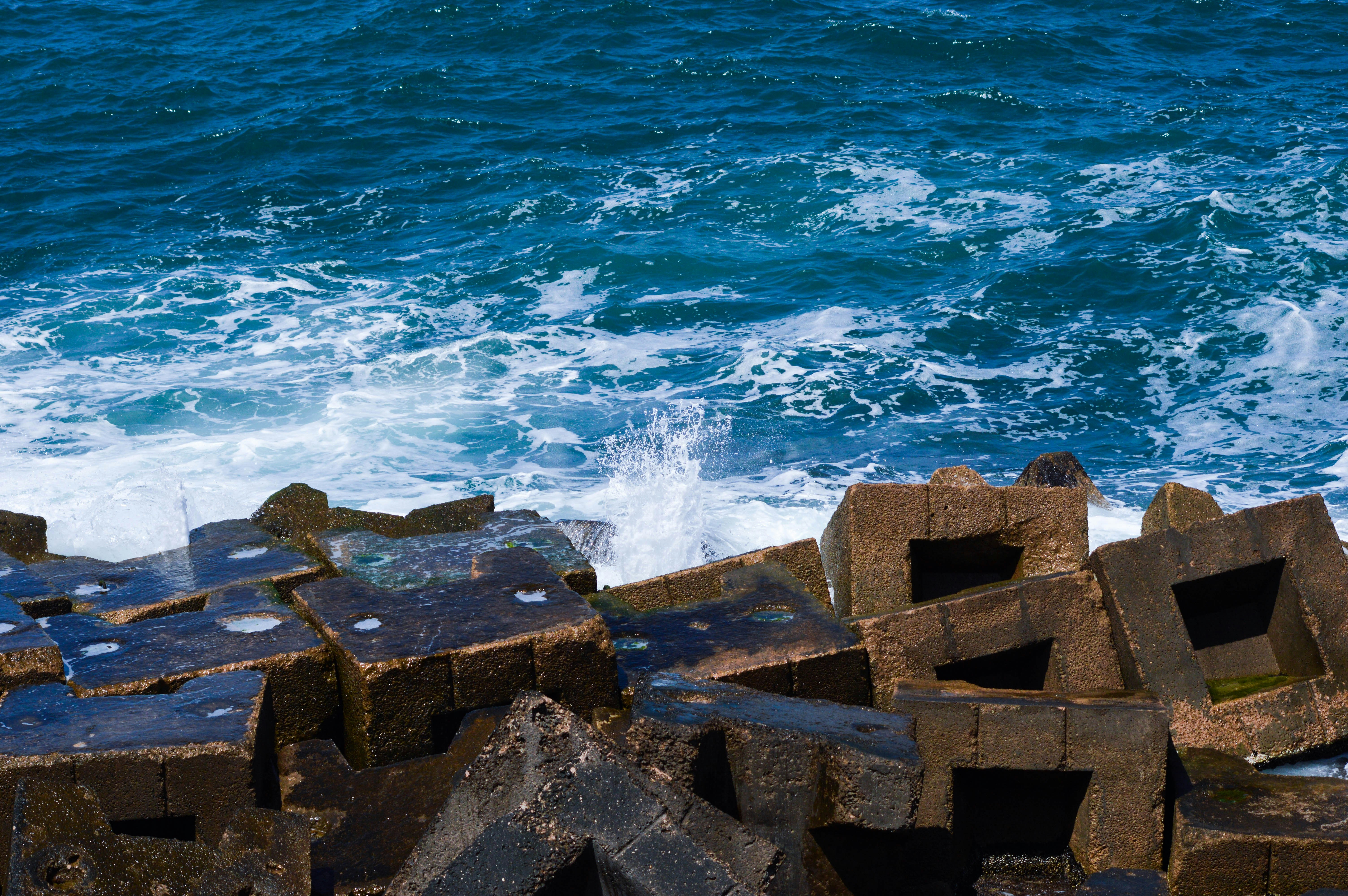 Brown concrete blocks near body of water during daytime photo – Free ...