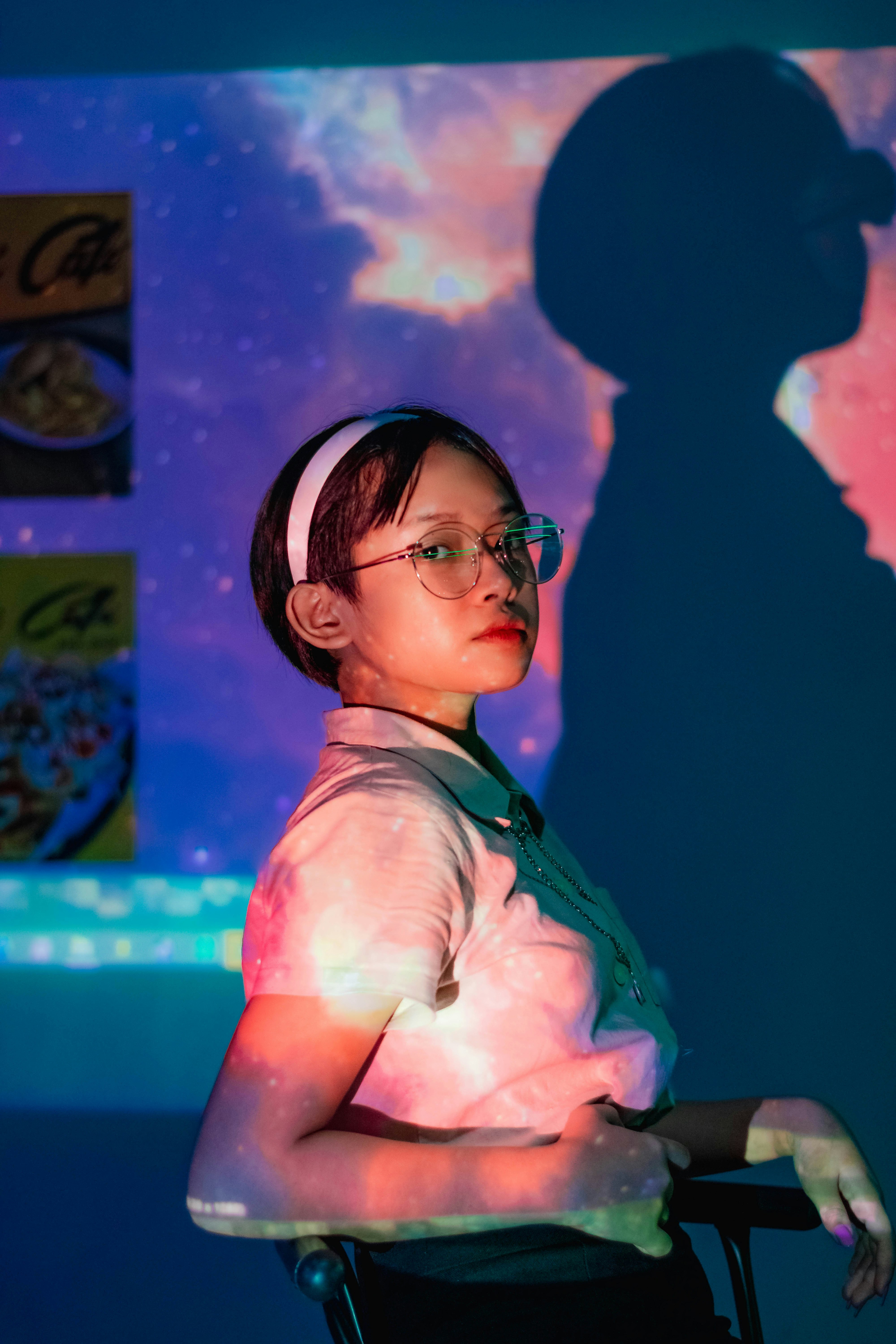 Portrait in a Neon Nebula: A Quiet Moment Amid Color and Shadow