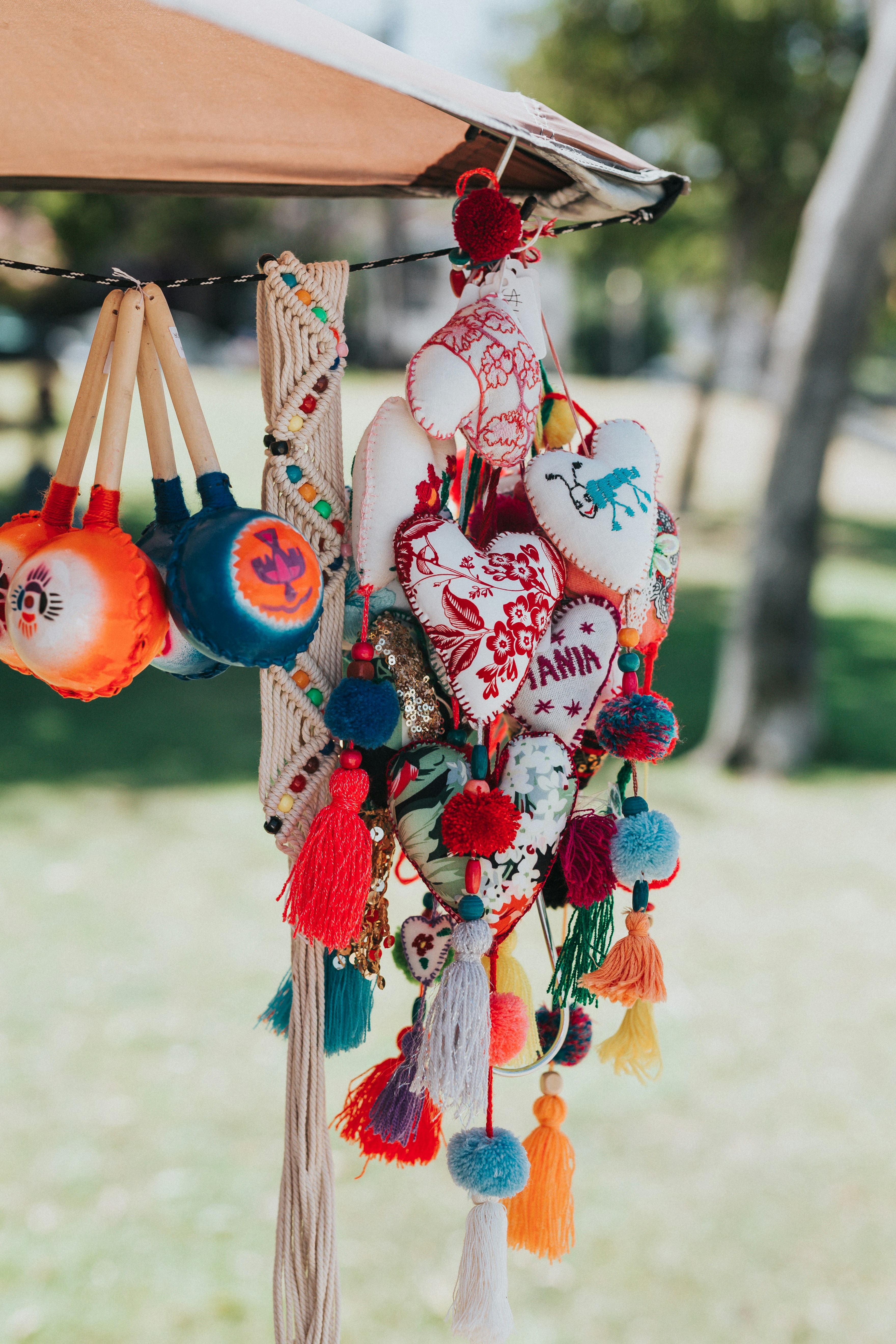 Kaleidoscope of Craft: Colorful Trinkets Dangling from a Market Stall