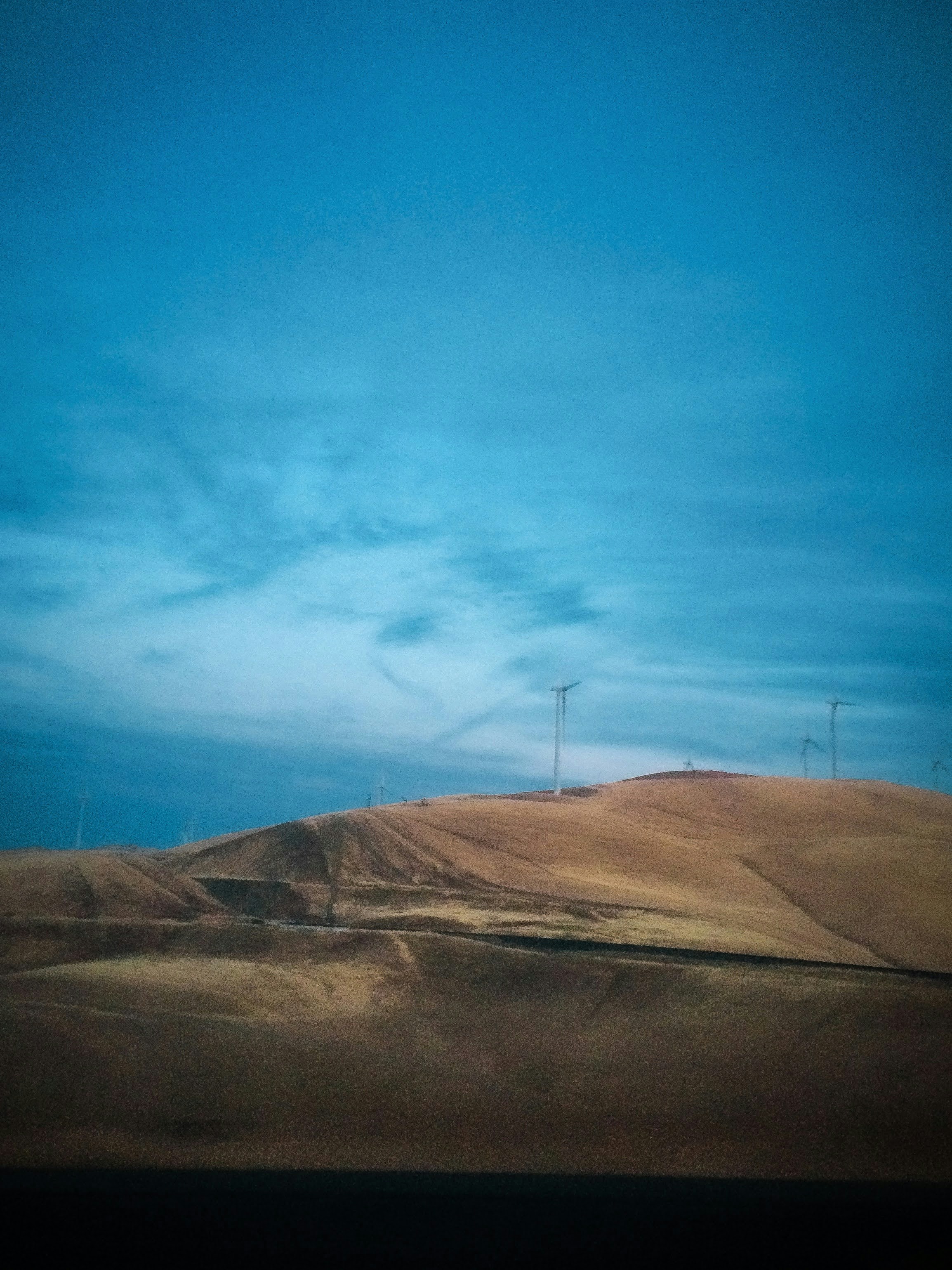 Wind turbines on brown field under blue sky during daytime photo – Free ...