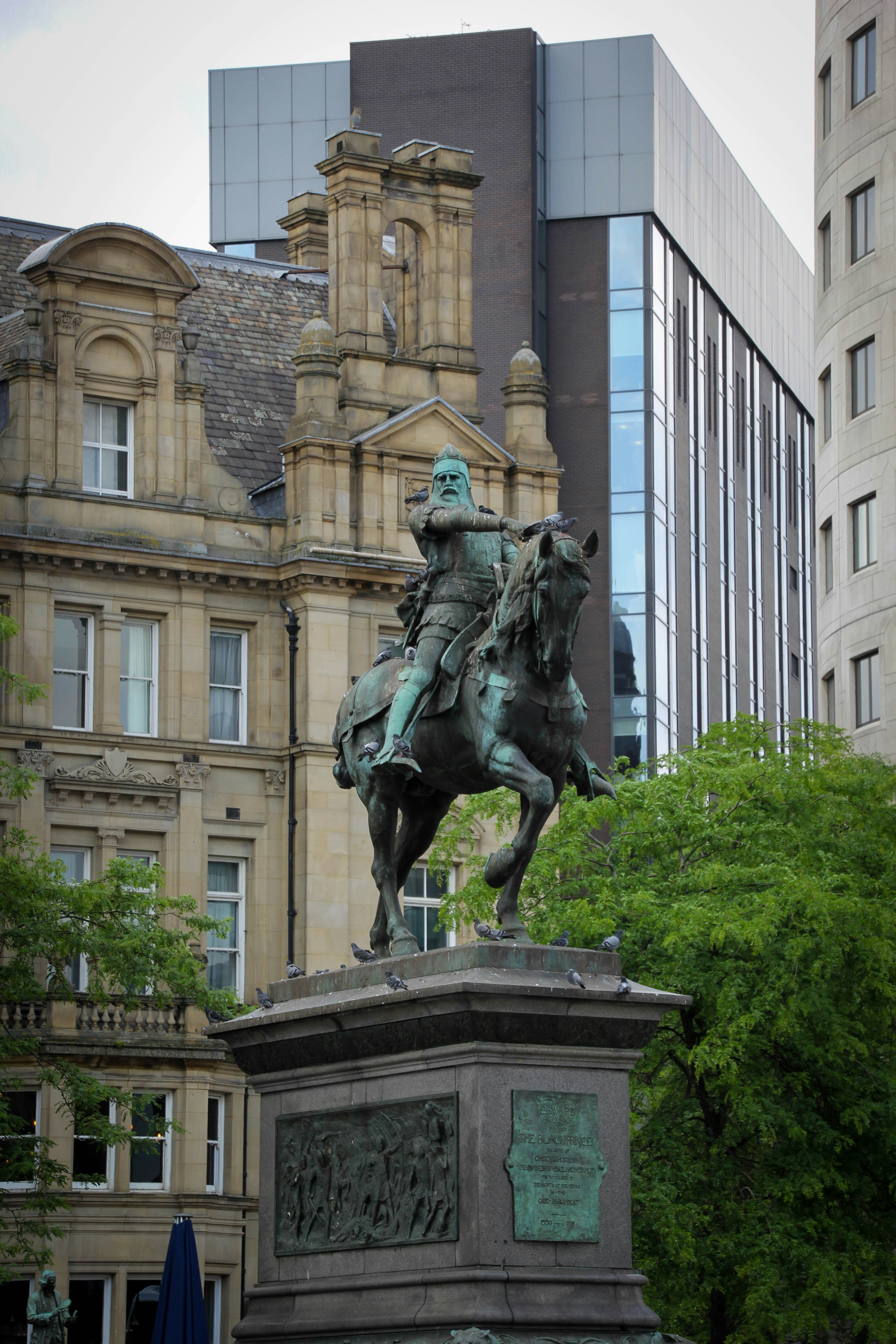Equestrian Bronze: City Monument Framed by Historic Facades and Modern Glass