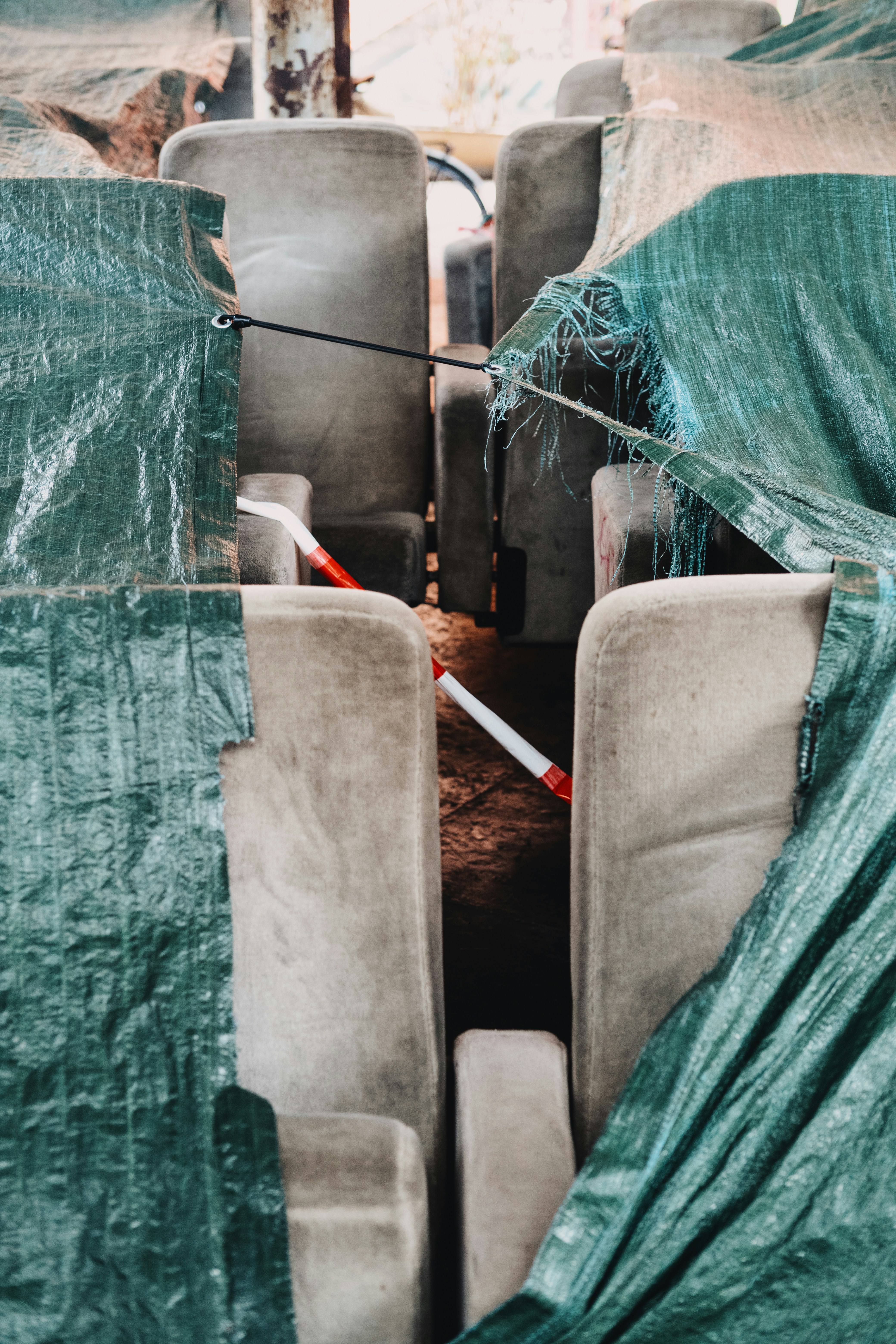 Forgotten Passenger Seats Beneath Tattered Covers