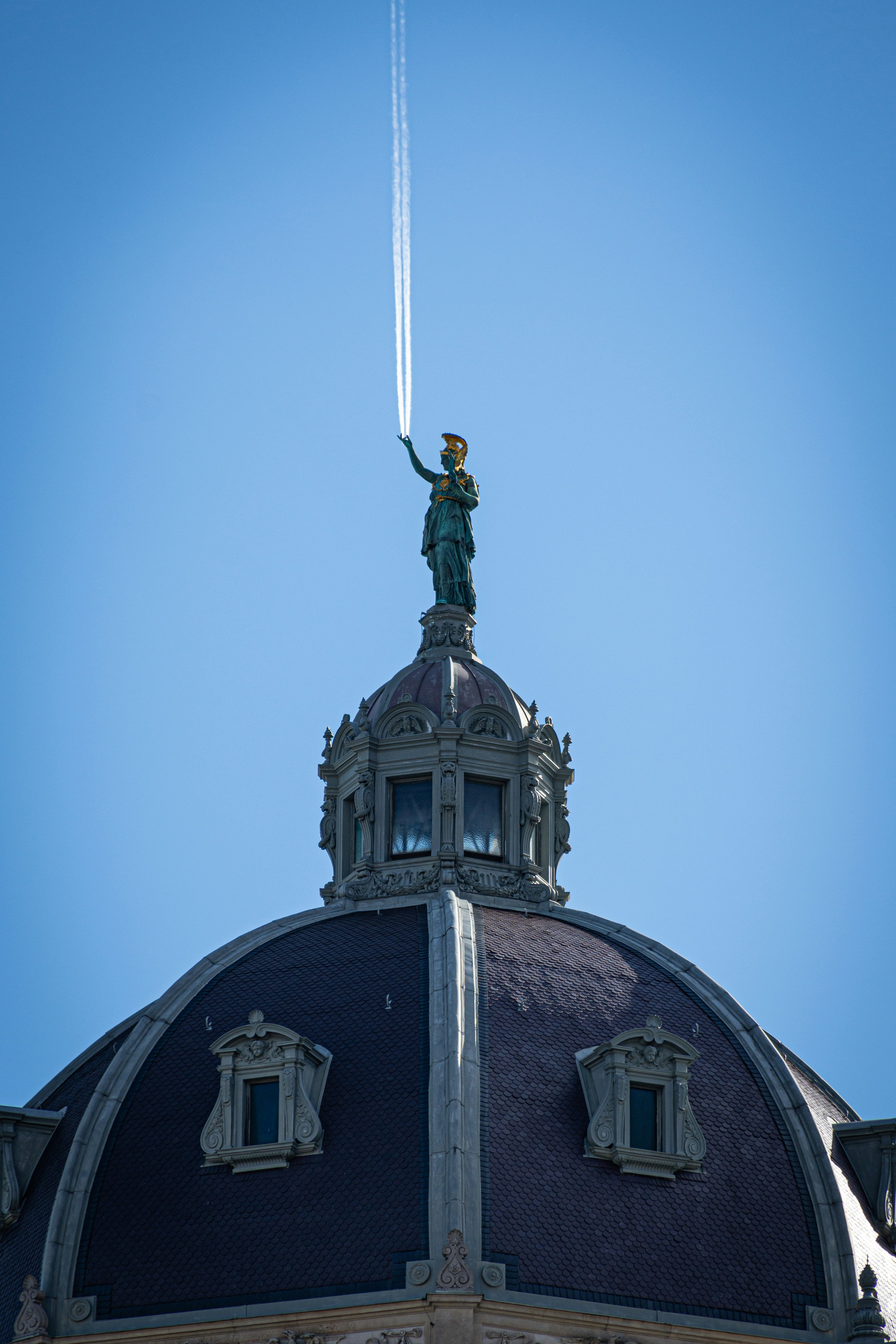 Apex Watcher Over a Baroque Dome Beneath a Sky-Splitting Contrail