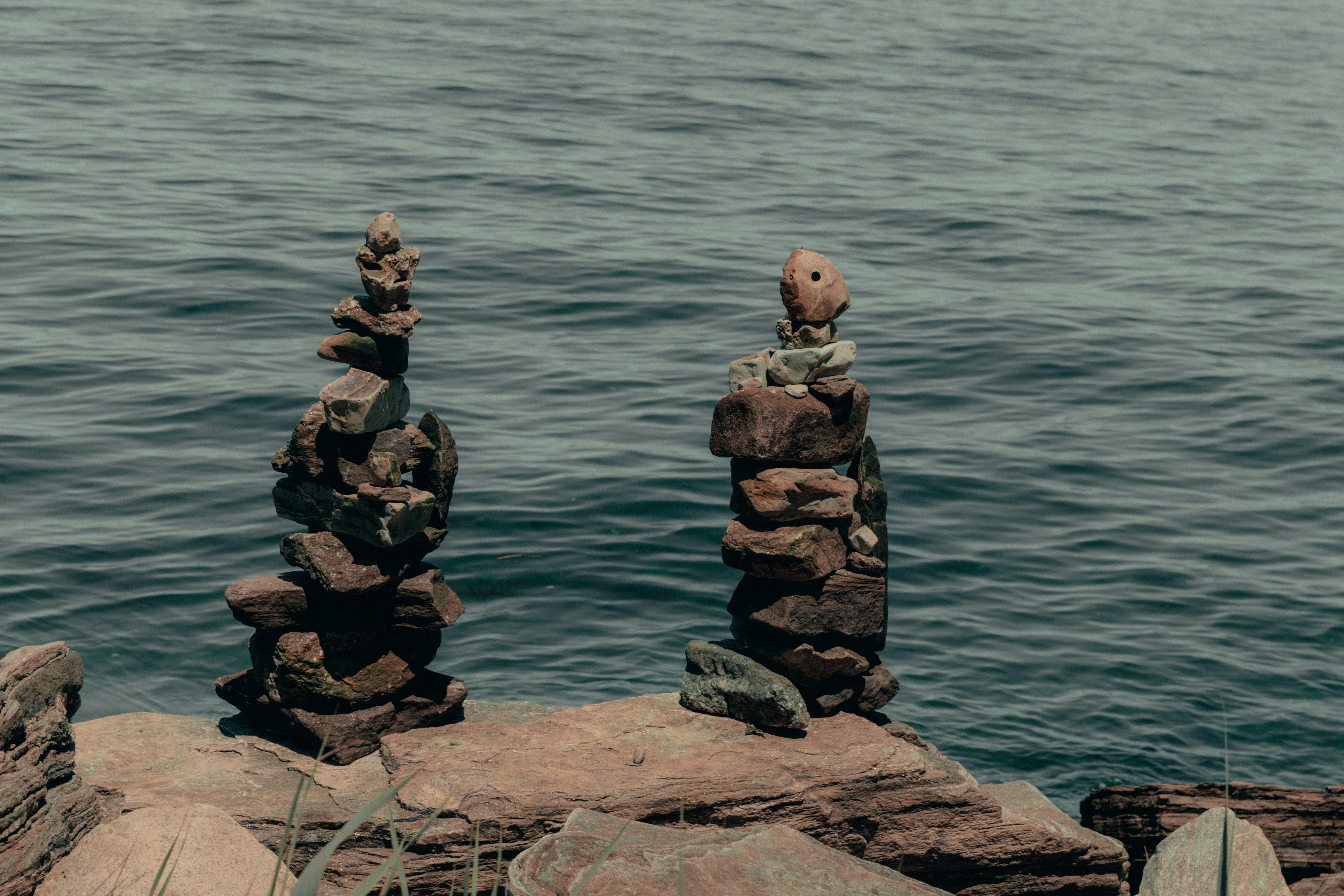 Brown rocks on body of water during daytime photo – Free Human Image on ...