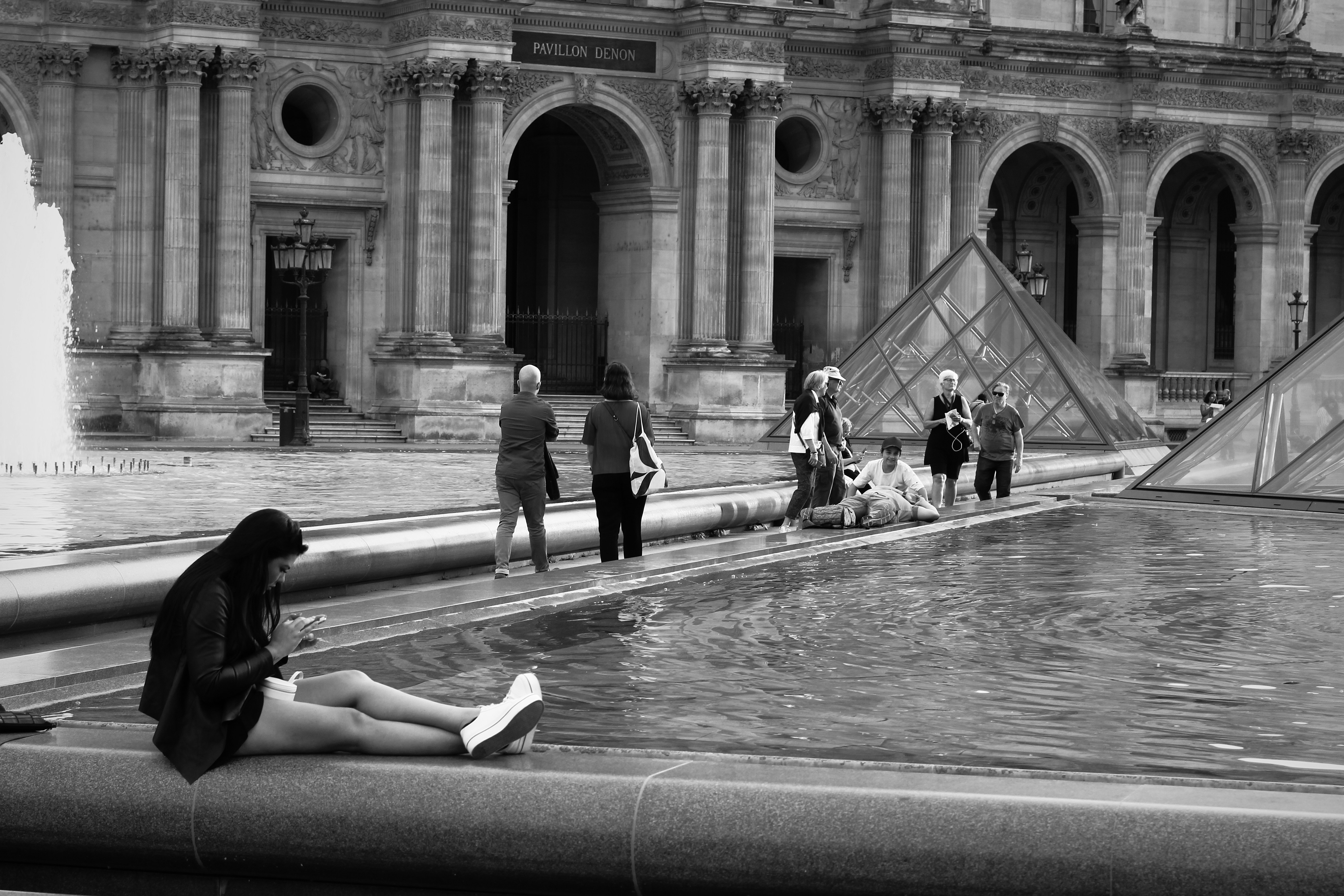 Solitary Moment by the Louvre Fountain: Quiet Light at the Glass Pyramids