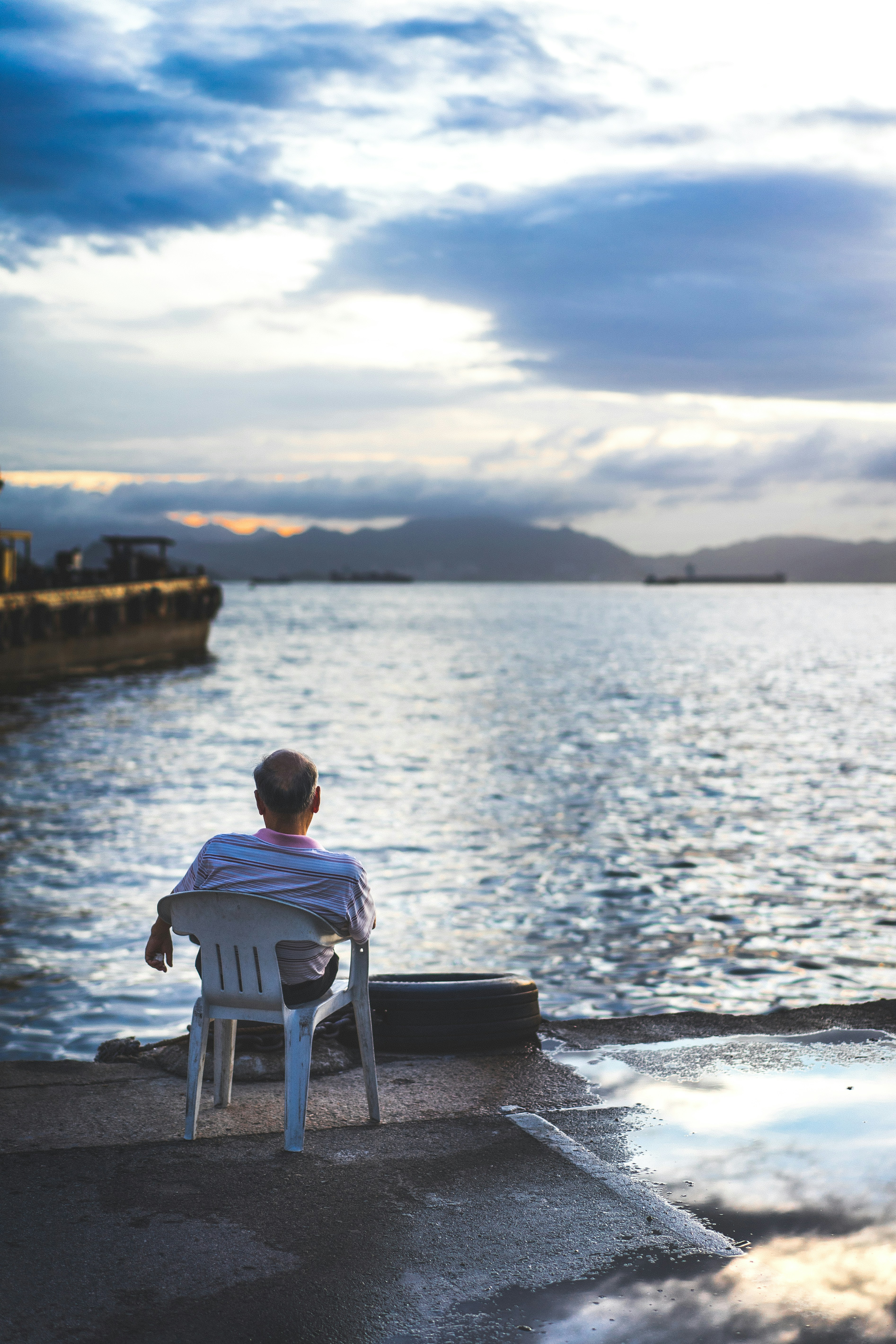 Harbor Reverie: A lone spectator at the edge of day