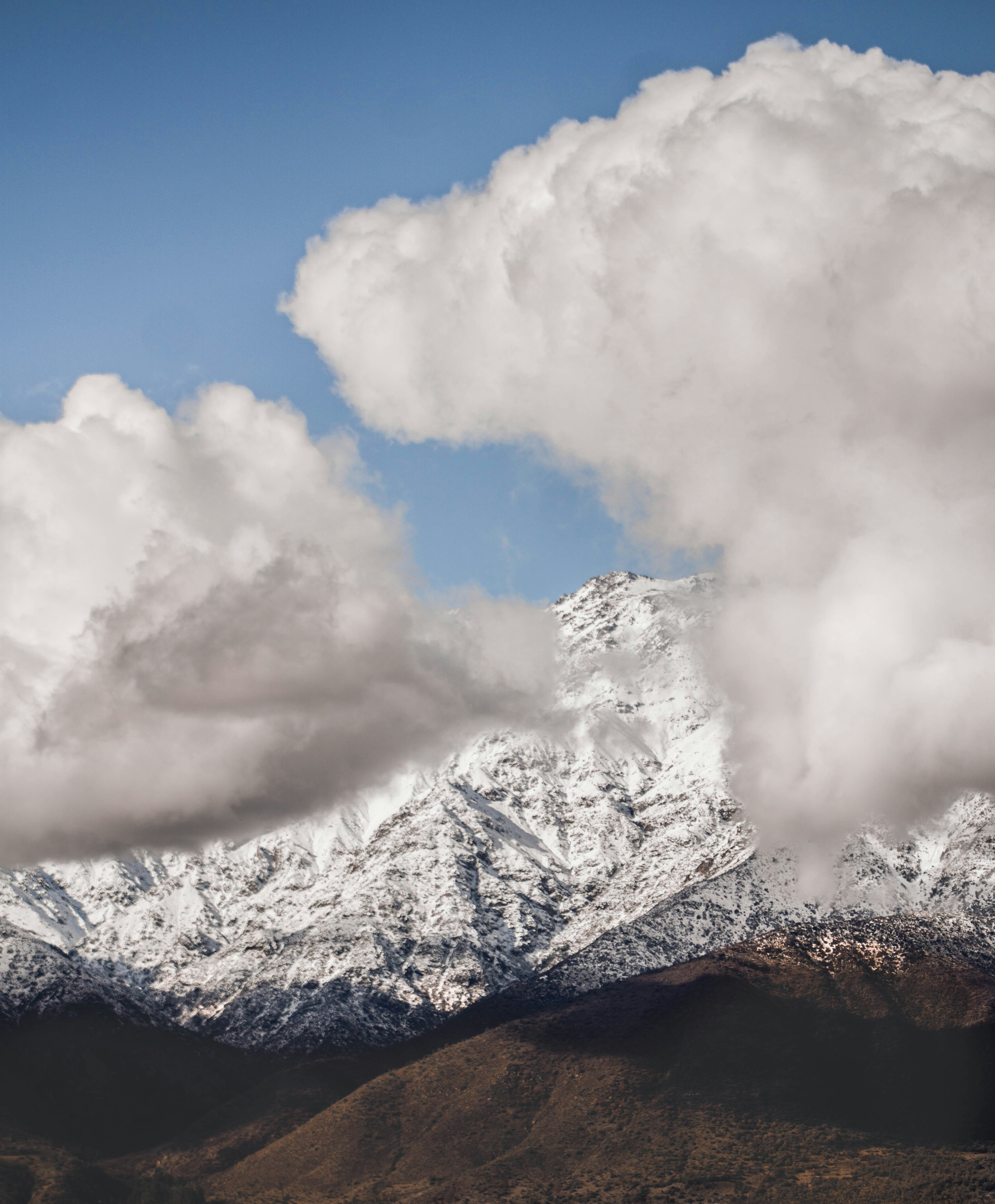 Majestic Peaks Cloaked in Cloudy Embrace