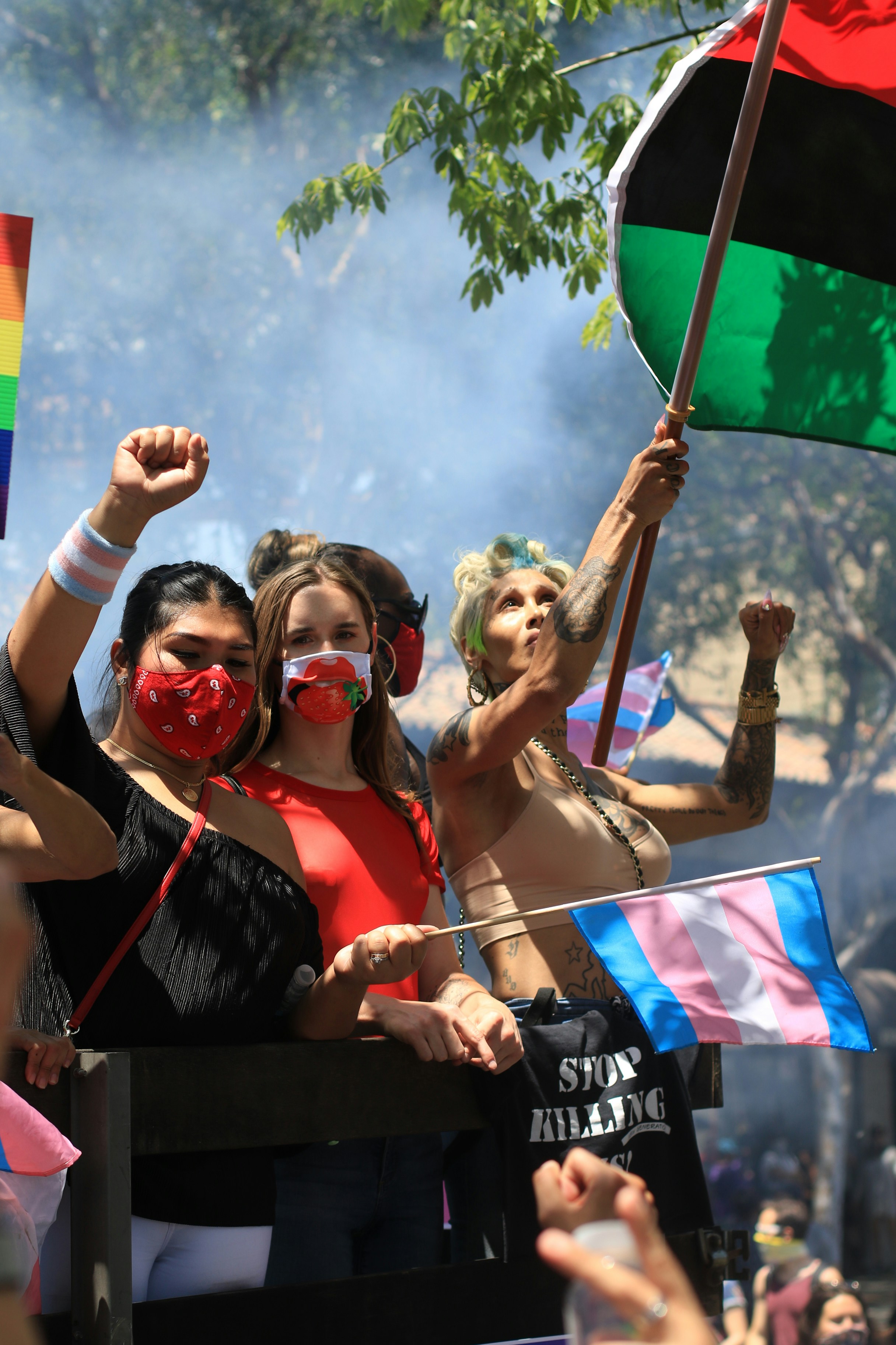 3 women holding flags during daytime