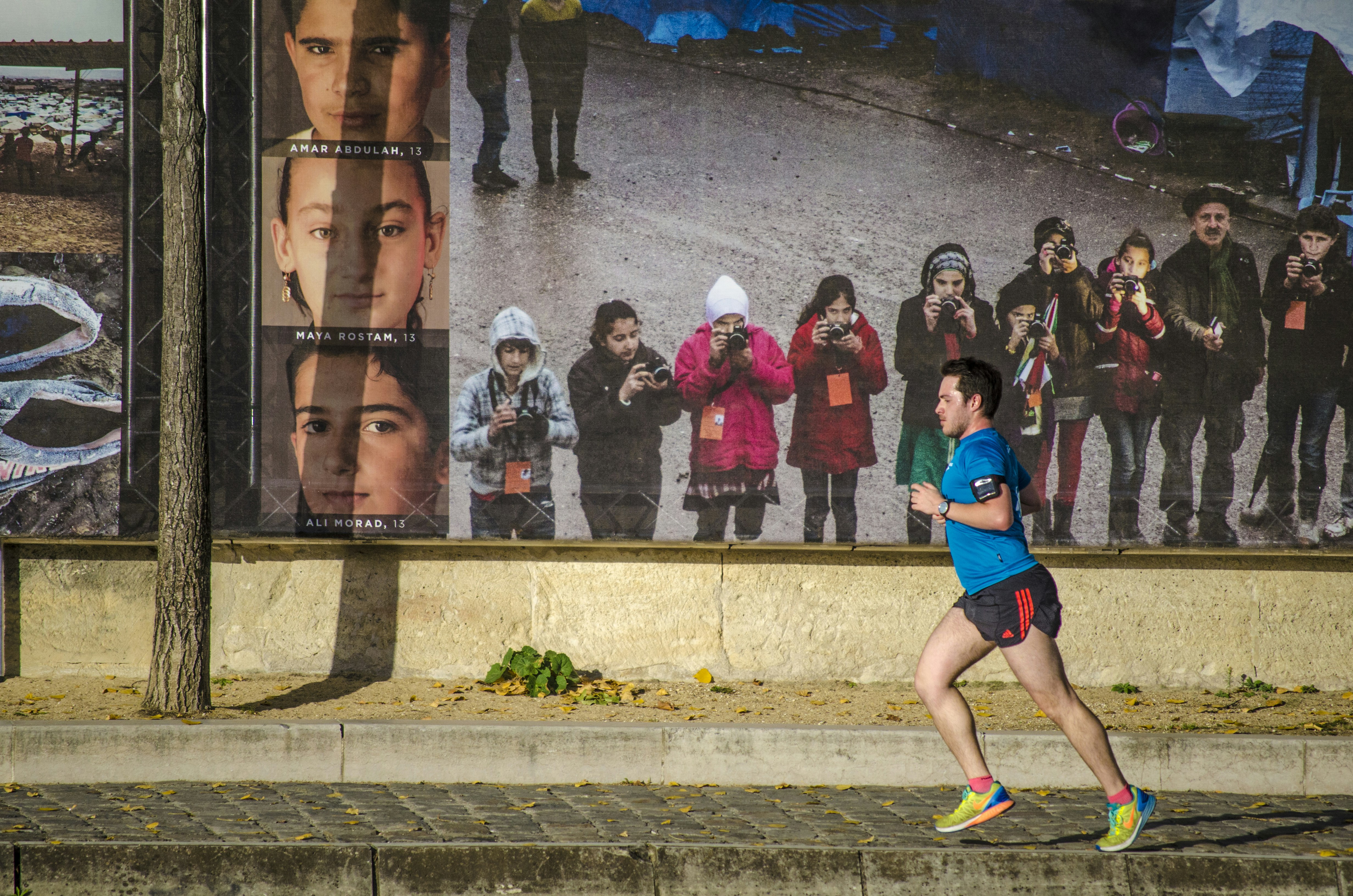 Blue Runner Across a Painted Crowd