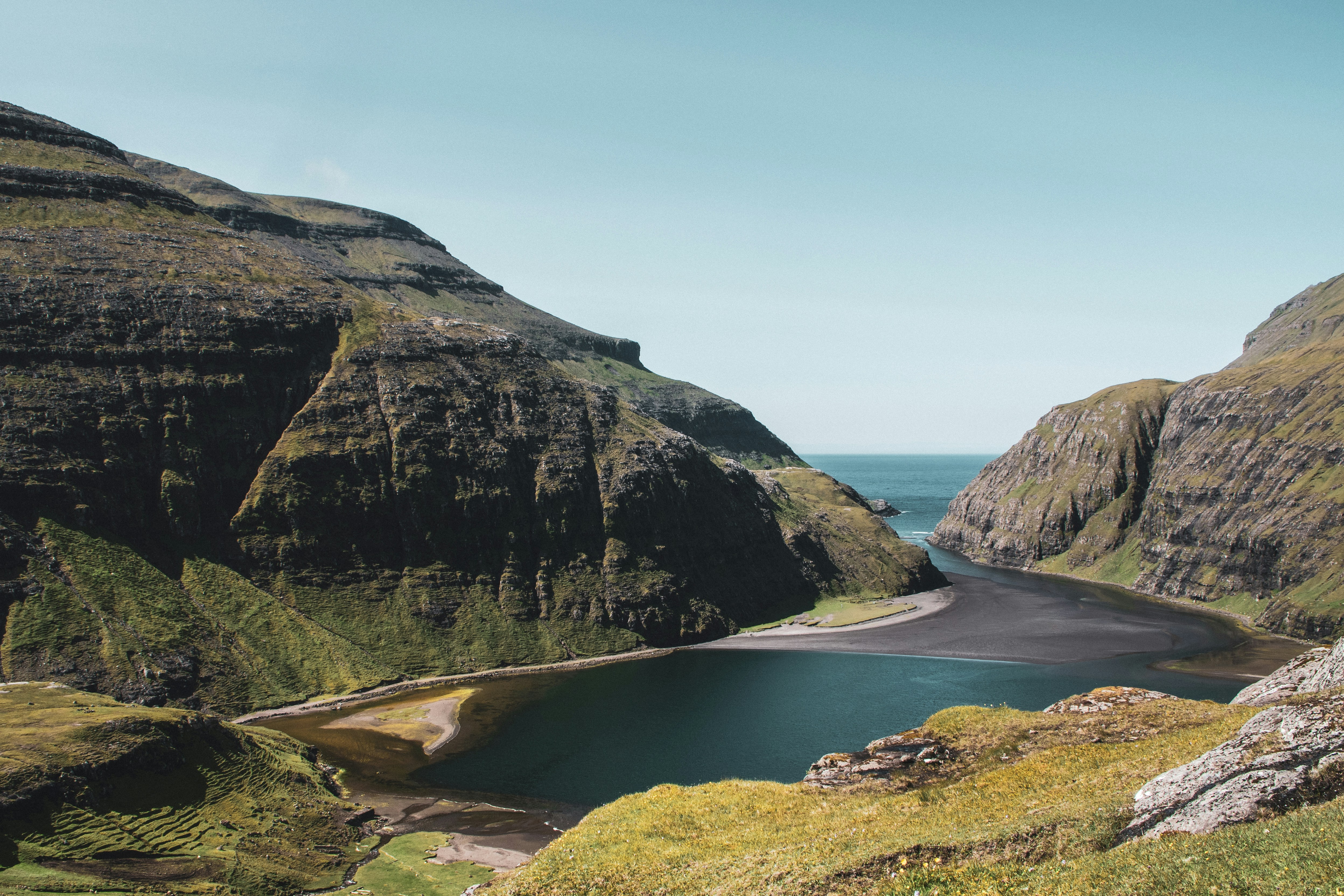 Seawater lagoon surrounded by high mountains in Saksun near the northwest coast of the Faroese island of Streymoy.