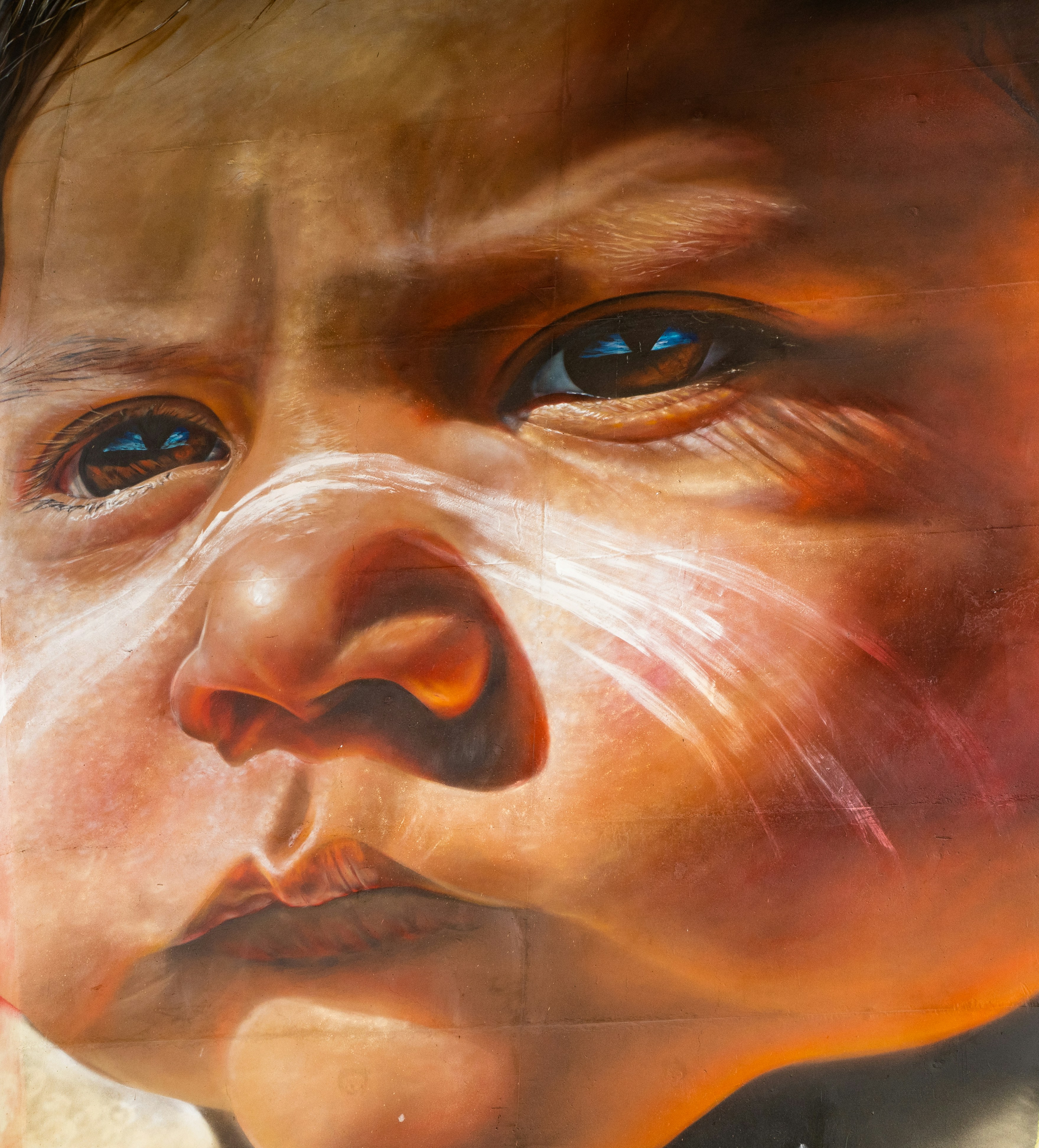 Warm Gaze on a Mural: A Close-Up Portrait in Ember Tones
