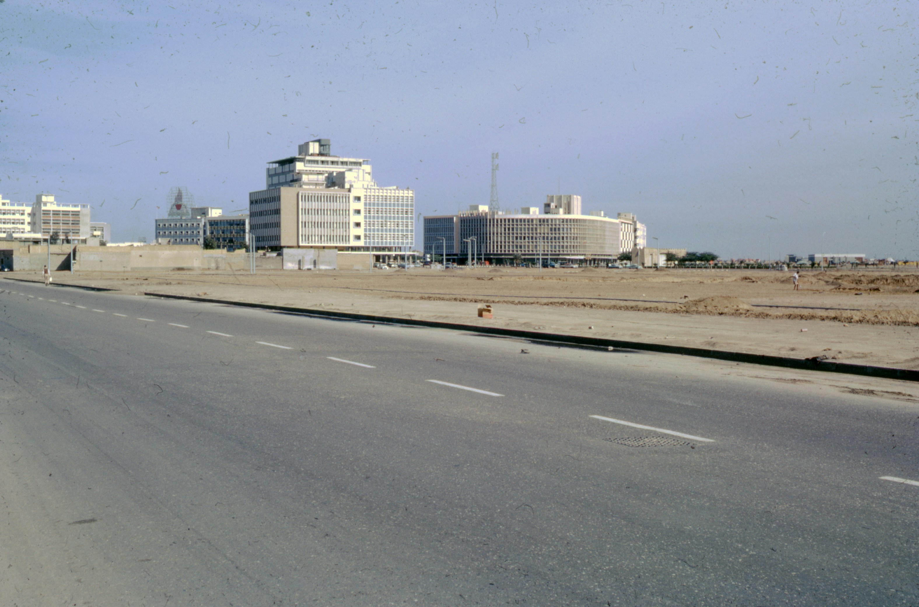 White concrete building near road under blue sky during daytime photo ...