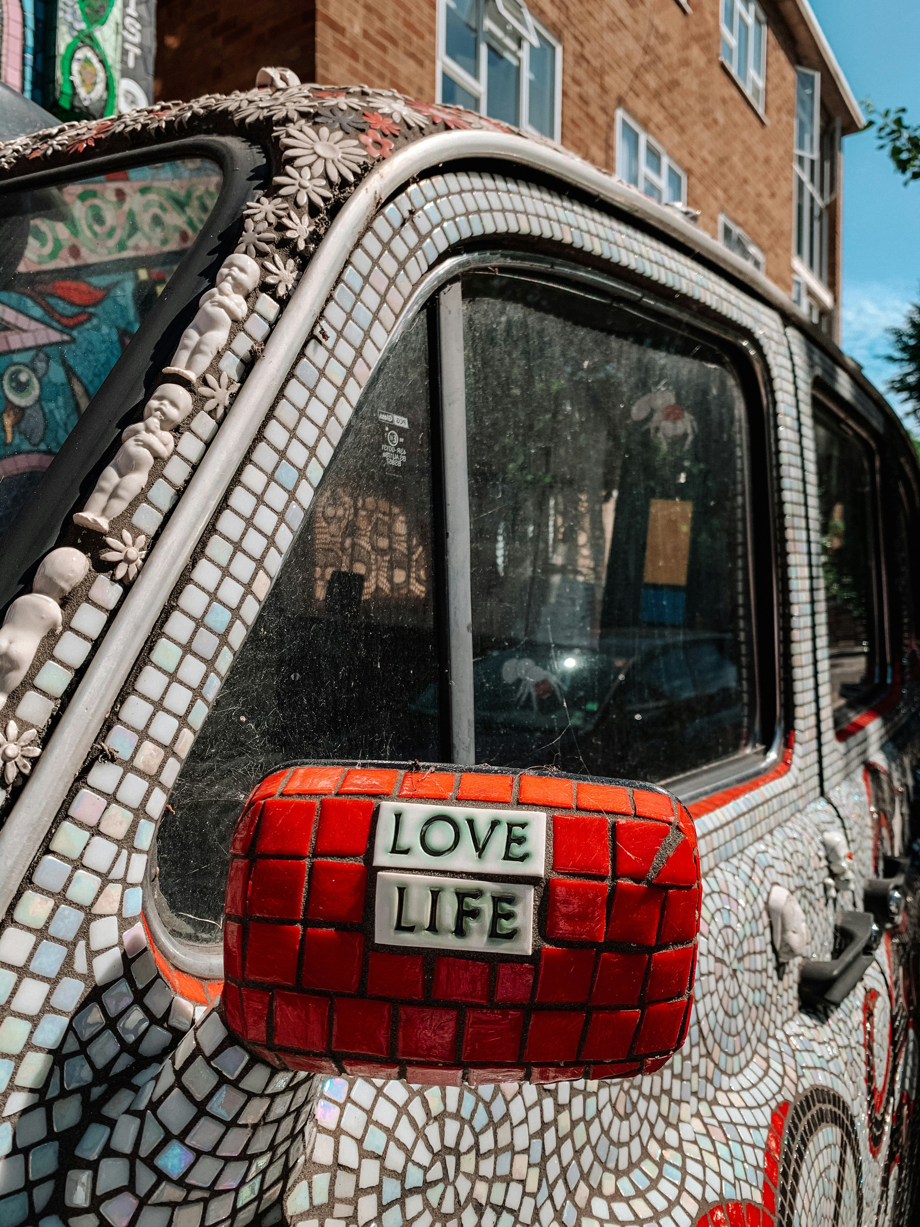 Mosaic Taxi: A Red Tile Embrace on the Side of the Streetcar