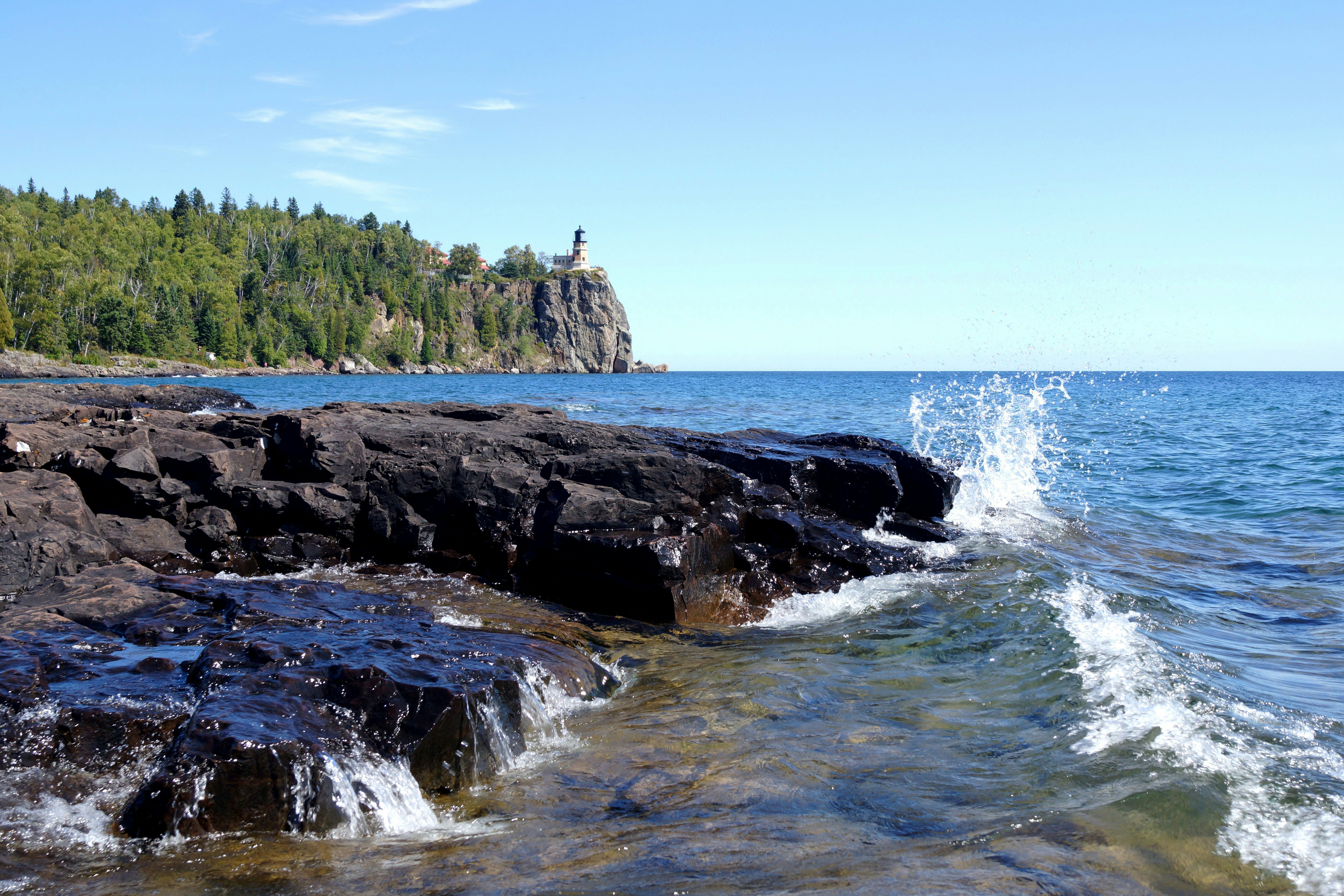 Split Rock Lighthouse State Park, Minnesota | rocky mountain beside body of water during daytime